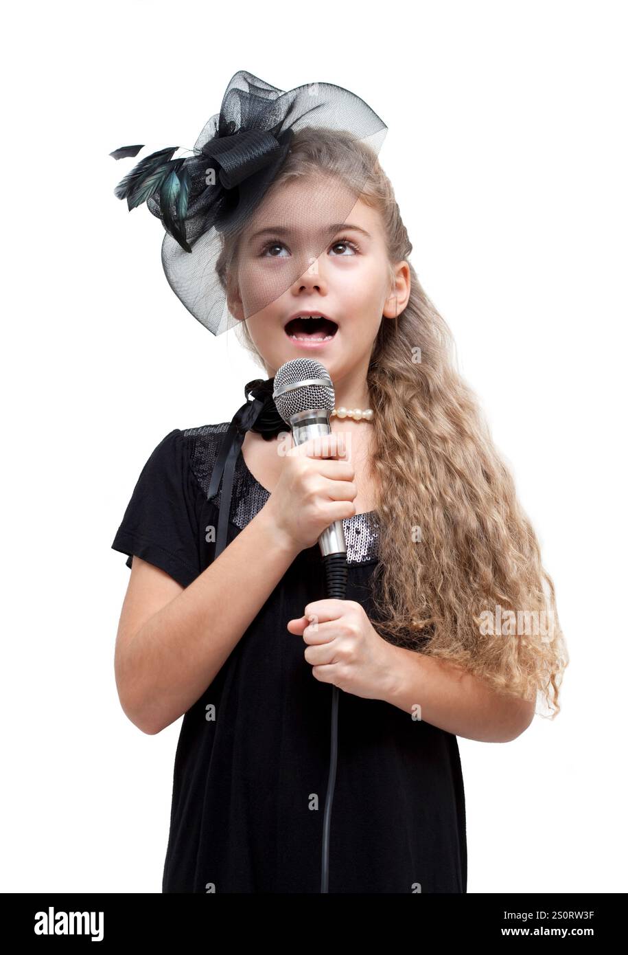 Cute little girl singing into a microphone on a white background Stock ...