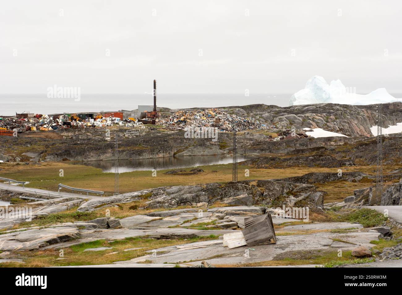 A landfill in Qeqertarsuaq, Greenland, surrounded by the stark and ...