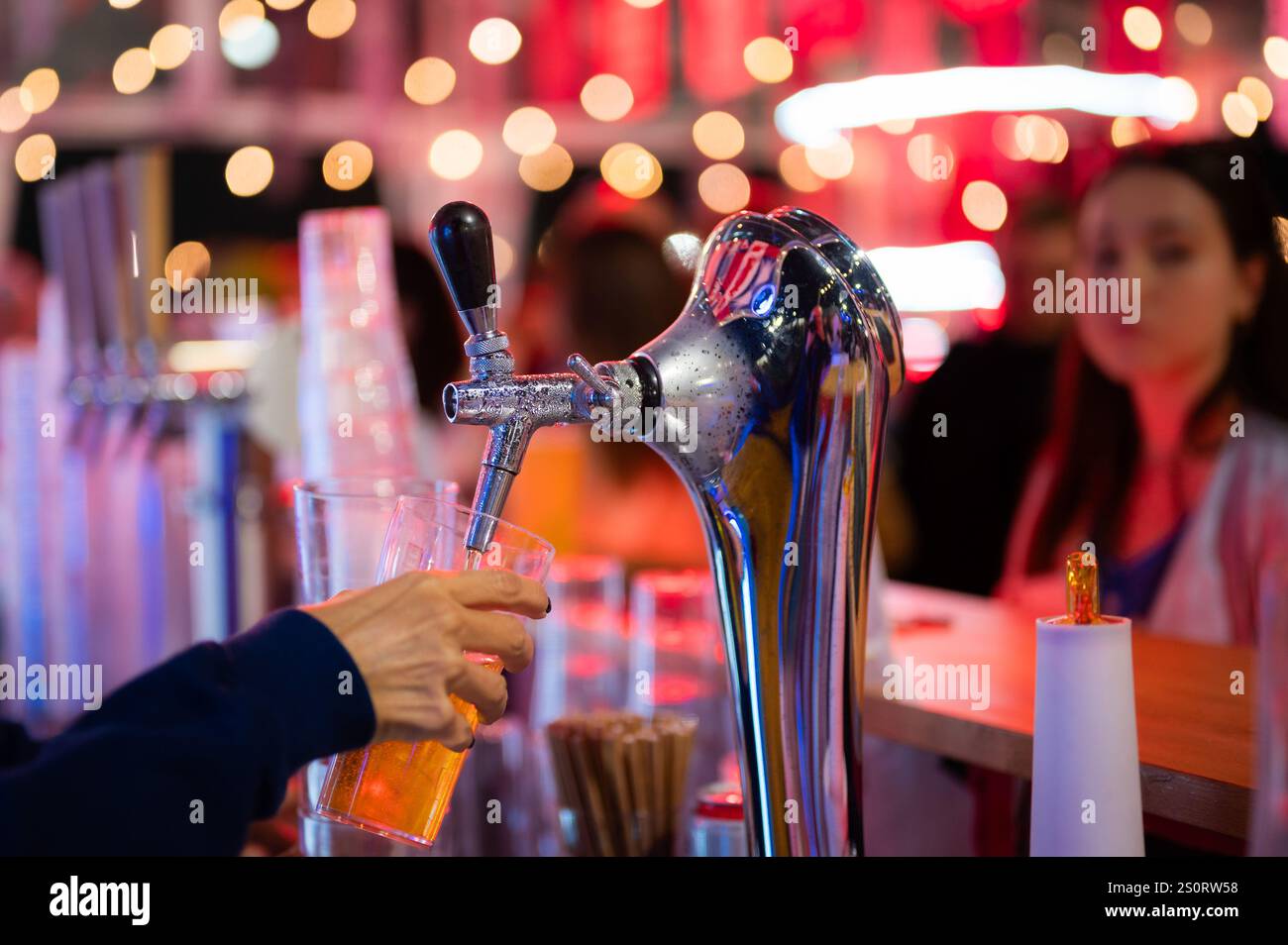pouring draft beer into a mug in a pub Stock Photo - Alamy