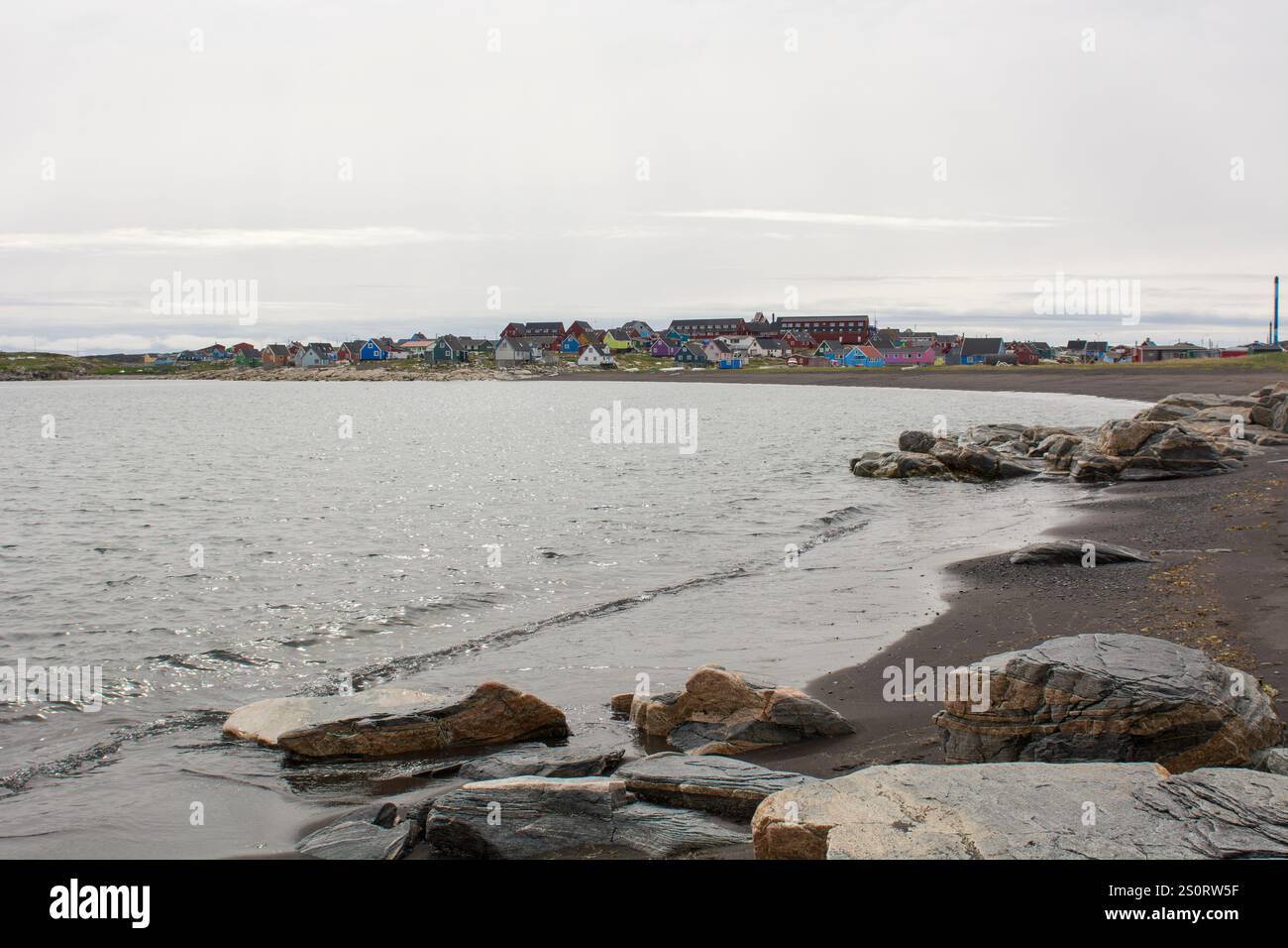 A picturesque image of Qeqertarsuaq, a charming town on Disko Island ...