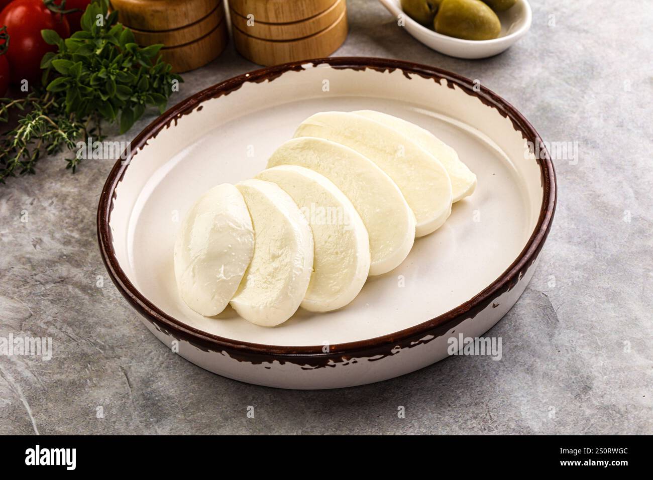 Organic mozzarella cheese slices in the plate appetizer Stock Photo - Alamy