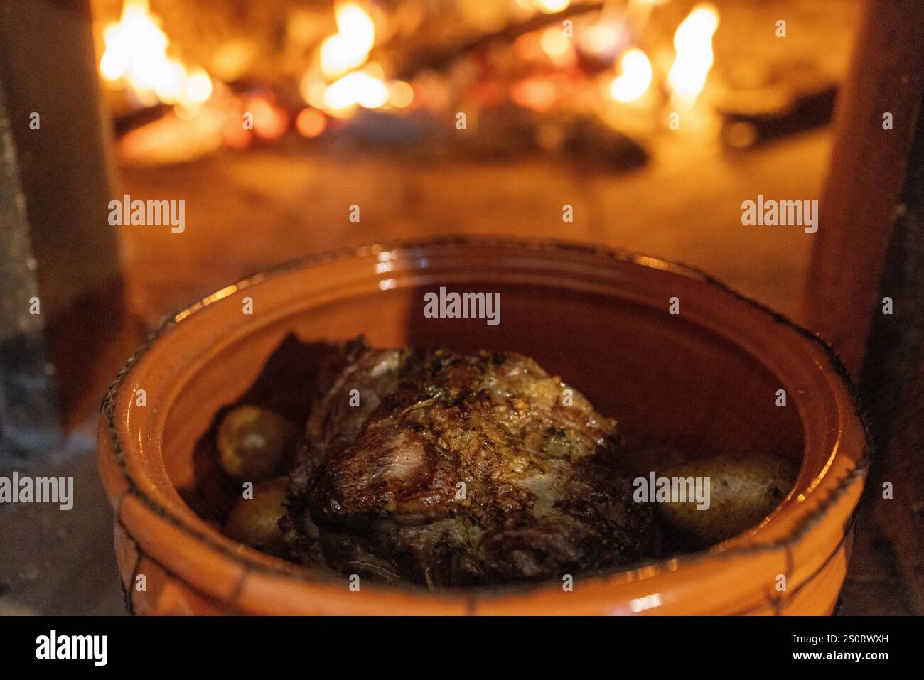 Roasted Meat and Potatoes in a Clay Pot Inside a Wood-Fired Oven Stock ...