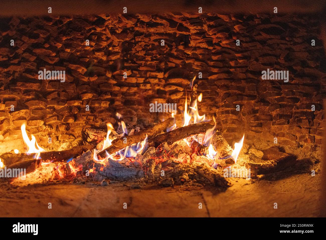 A warm and cozy scene inside a traditional brick oven with glowing ...