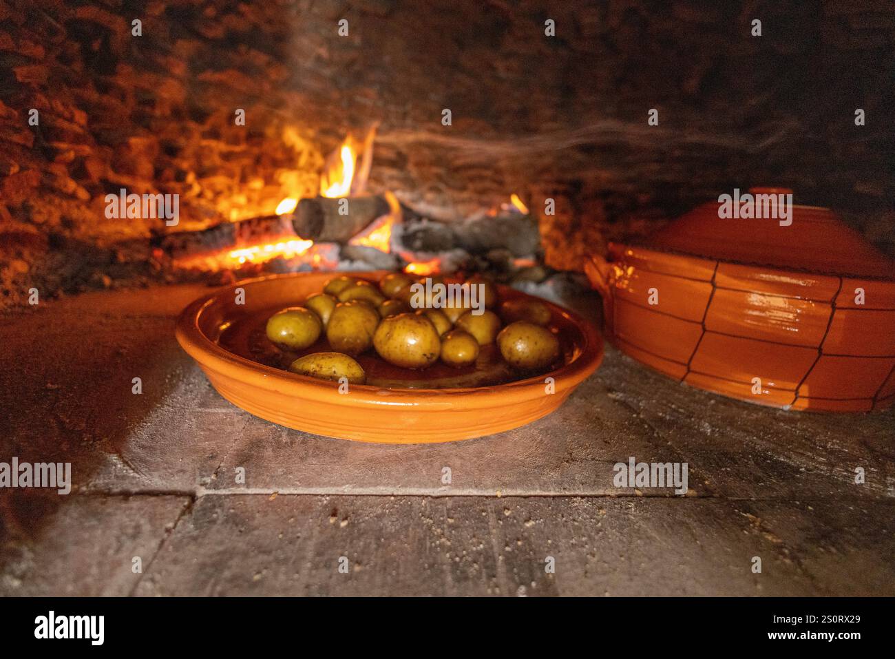 Rustic Clay Pot Cooking in a Traditional Wood-Fired Oven Stock Photo ...