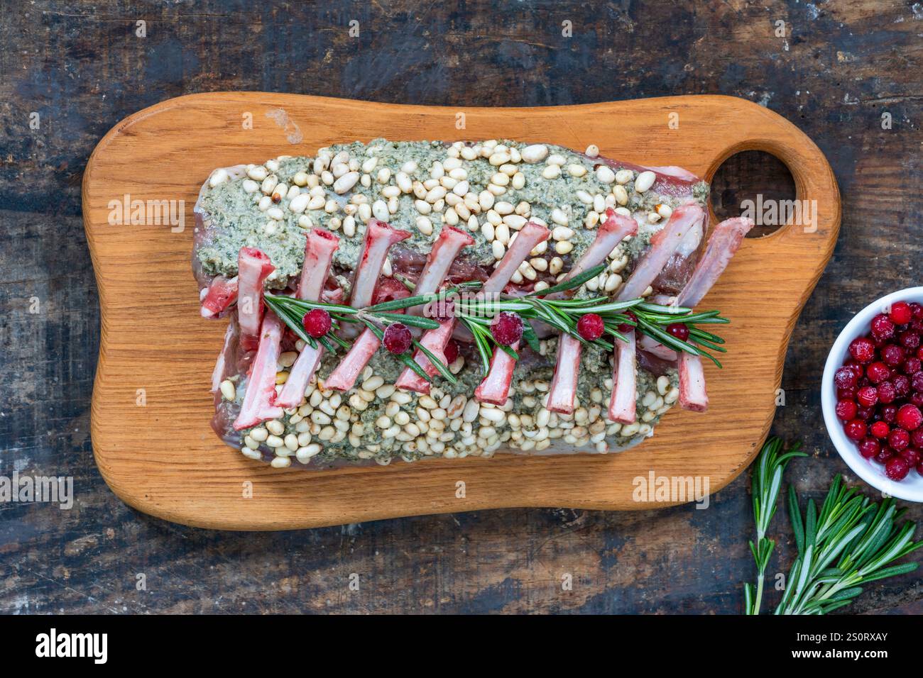 Raw rack of lamb with mint, basil and pine nuts pesto Stock Photo - Alamy
