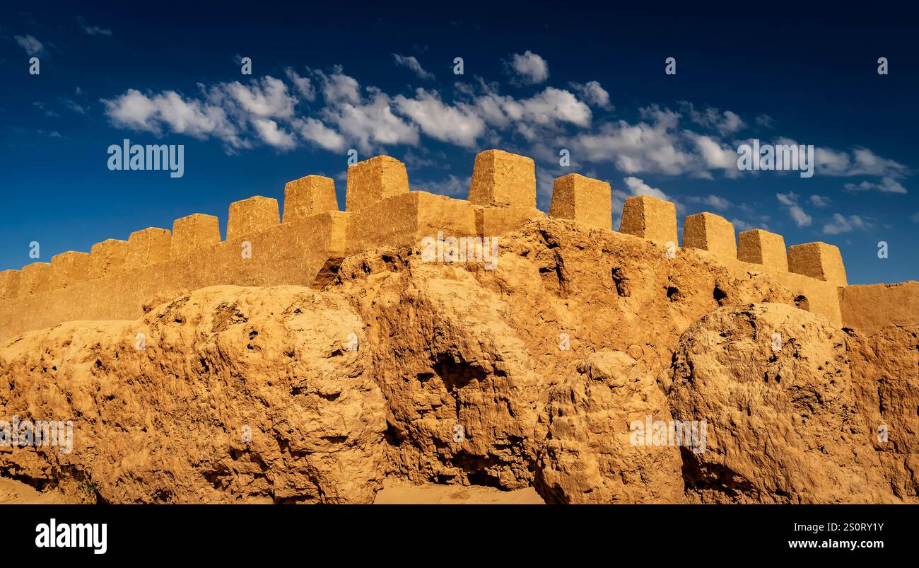 A historic fortress made of mud bricks, standing on a rocky terrain ...