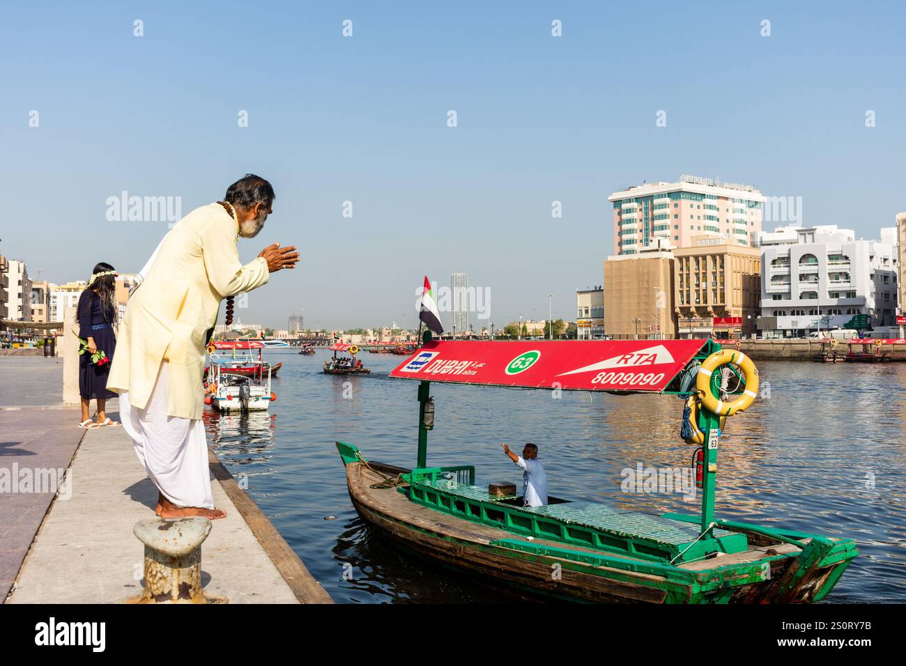 An Indian man is performing a ritual by the waterfront in Bur Dubai ...