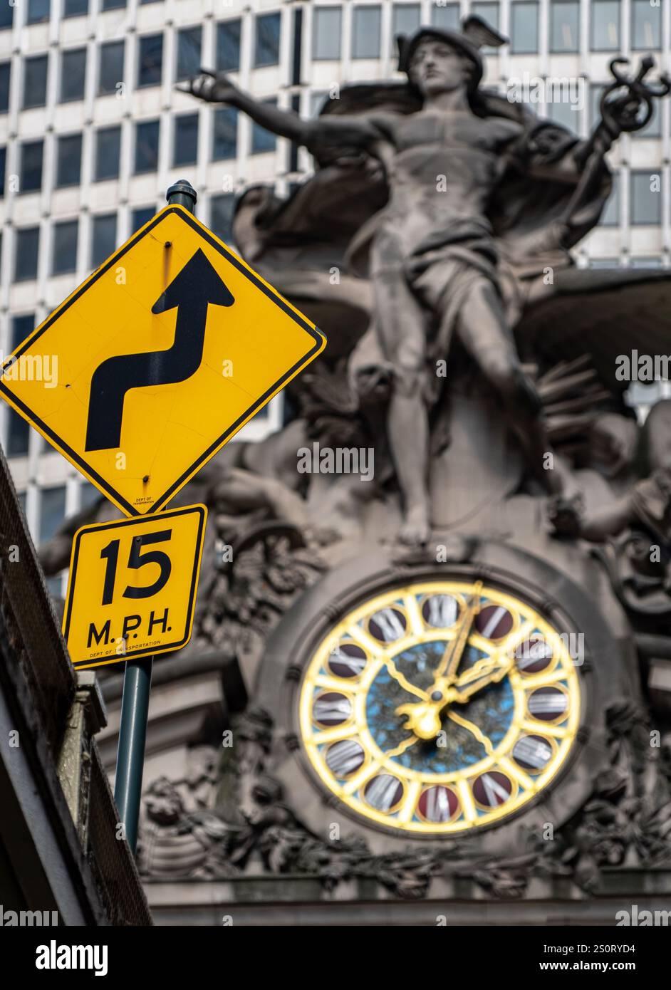 A close-up of a yellow road sign indicating a sharp turn ahead, with a ...
