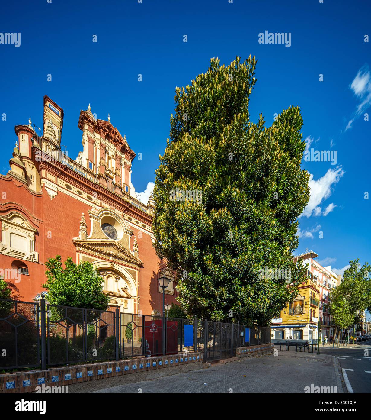 Historic baroque Iglesia de San Jacinto framed by lush greenery in ...
