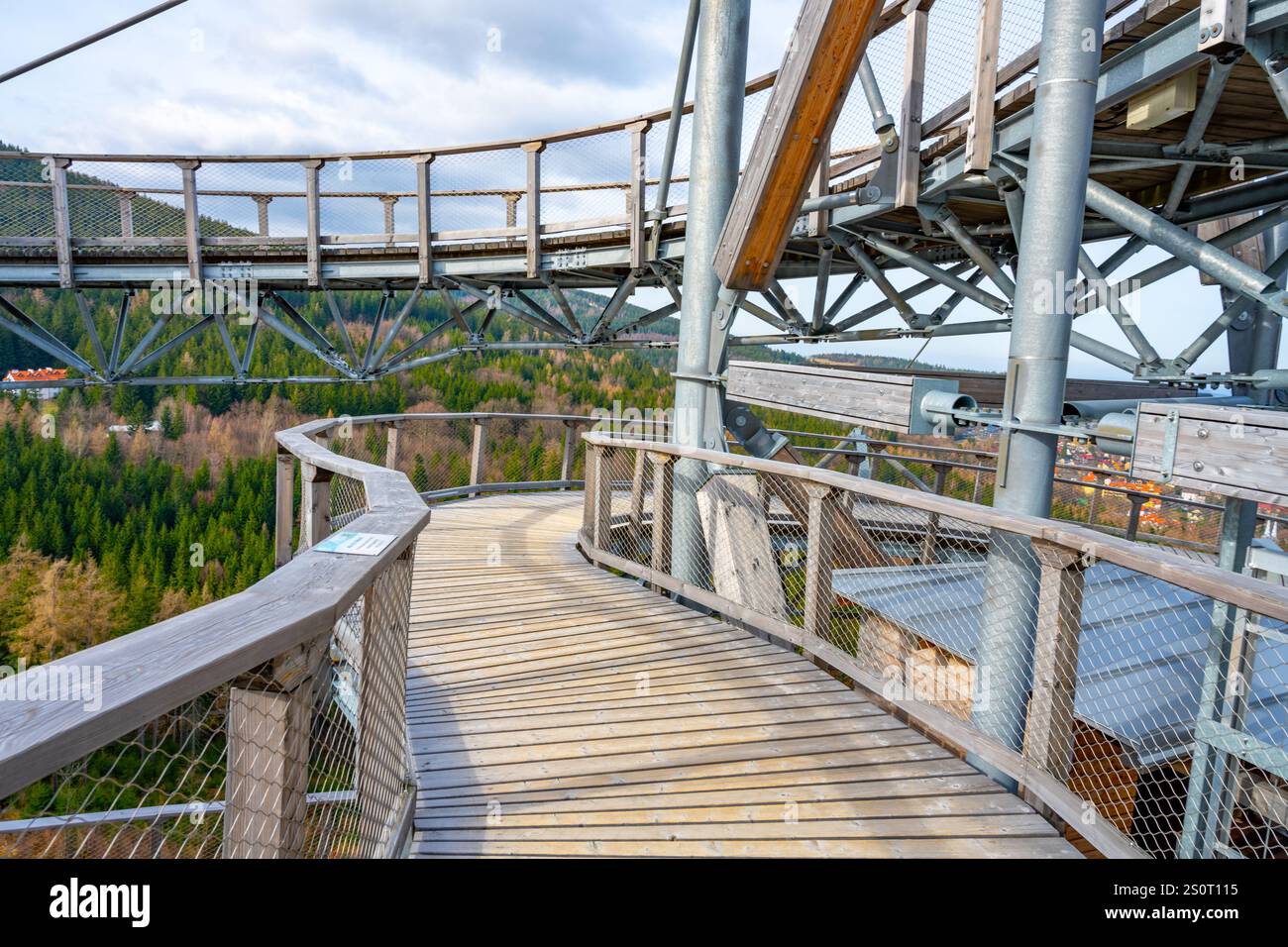 Visitors enjoy a leisurely stroll along the elevated wooden walkway of ...
