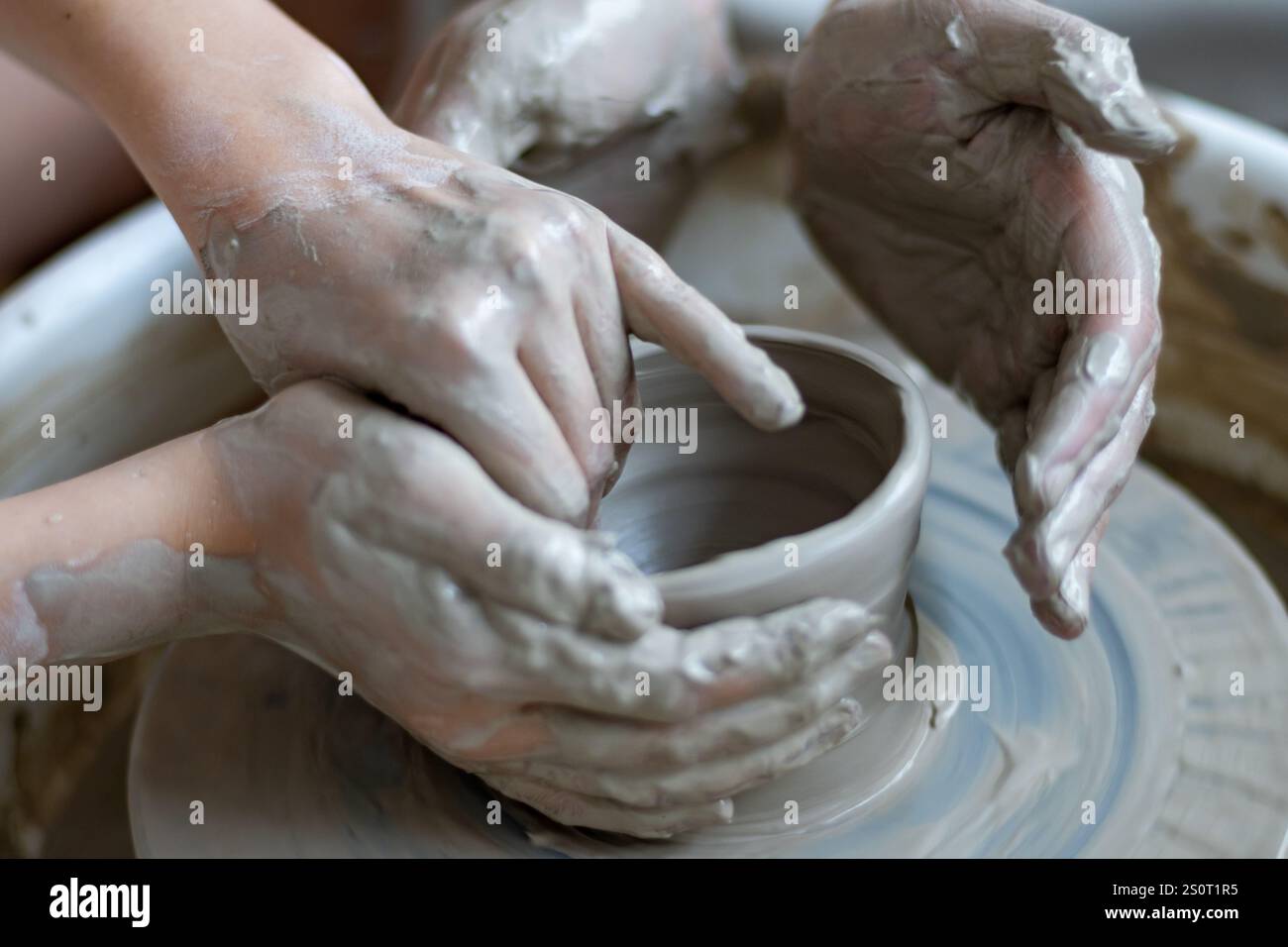 Making of mud pot on potters wheel during workshop in design modern art ...