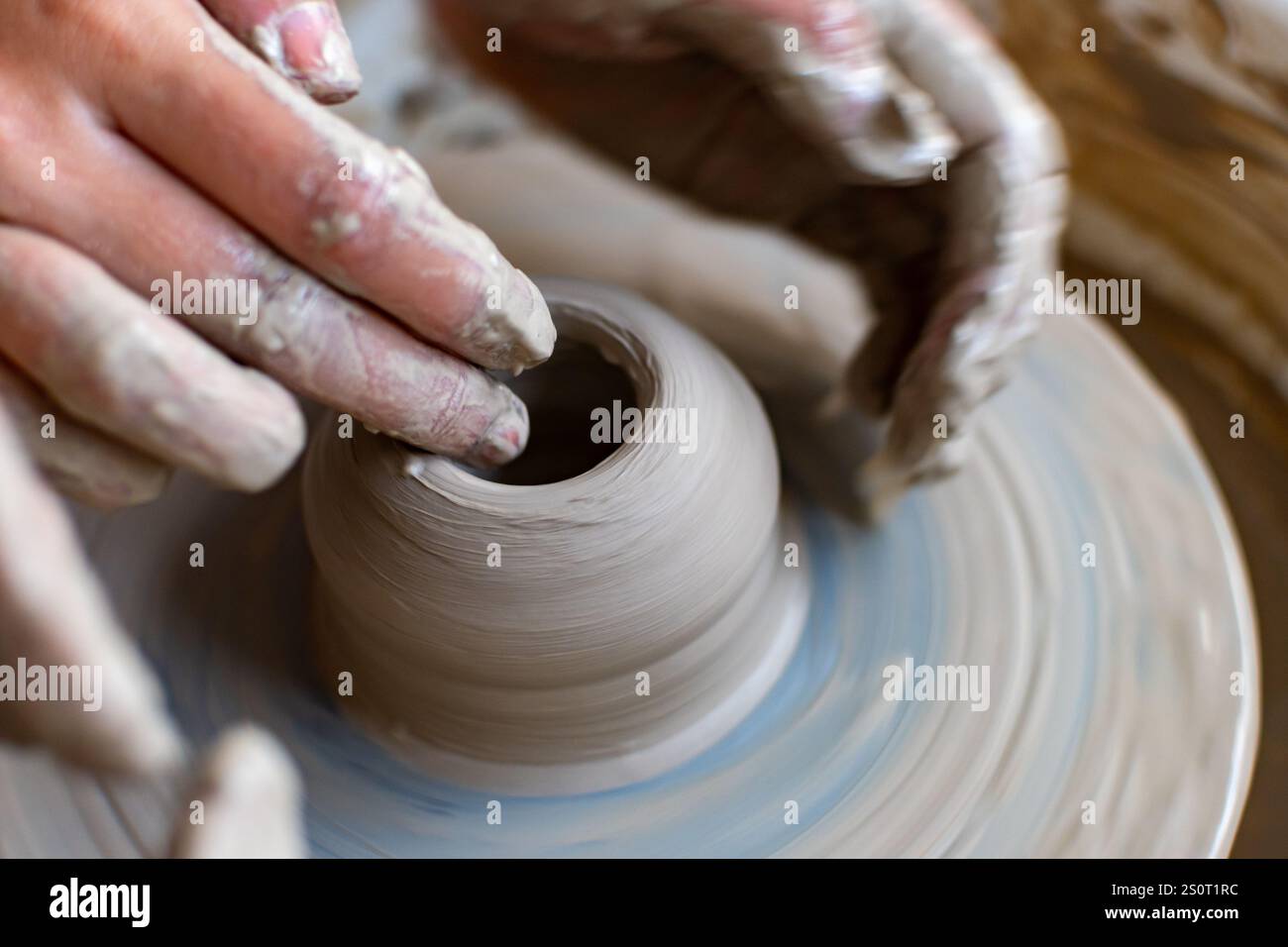 Making of mud pot on potters wheel during workshop in design modern art ...