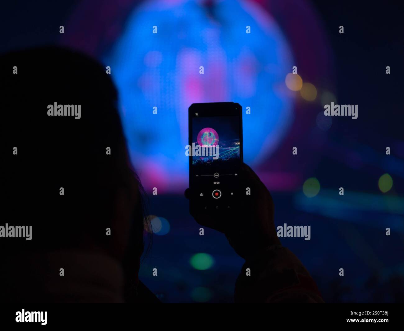Tourists are filming a light and sound show using their smartphones ...