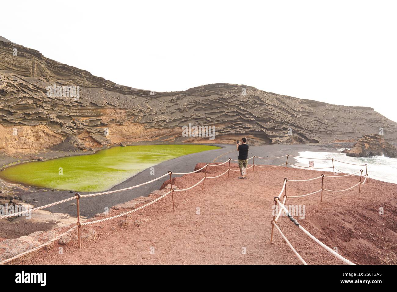 The unique green lagoon on the black sand beach of El Golfo, Lanzarote ...