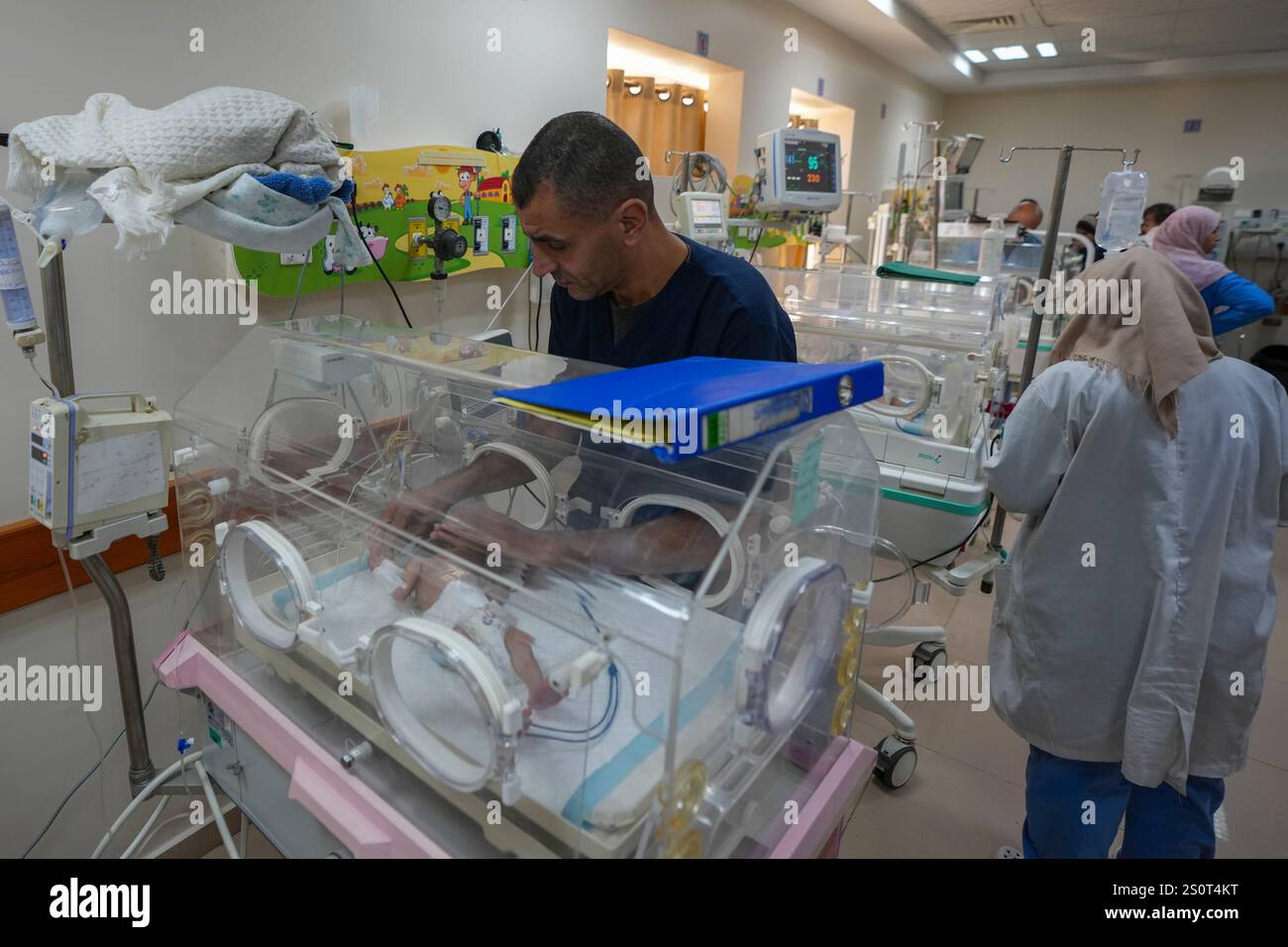 Ali al-Batran, a 20-day-old infant, lies in the intensive care unit ...