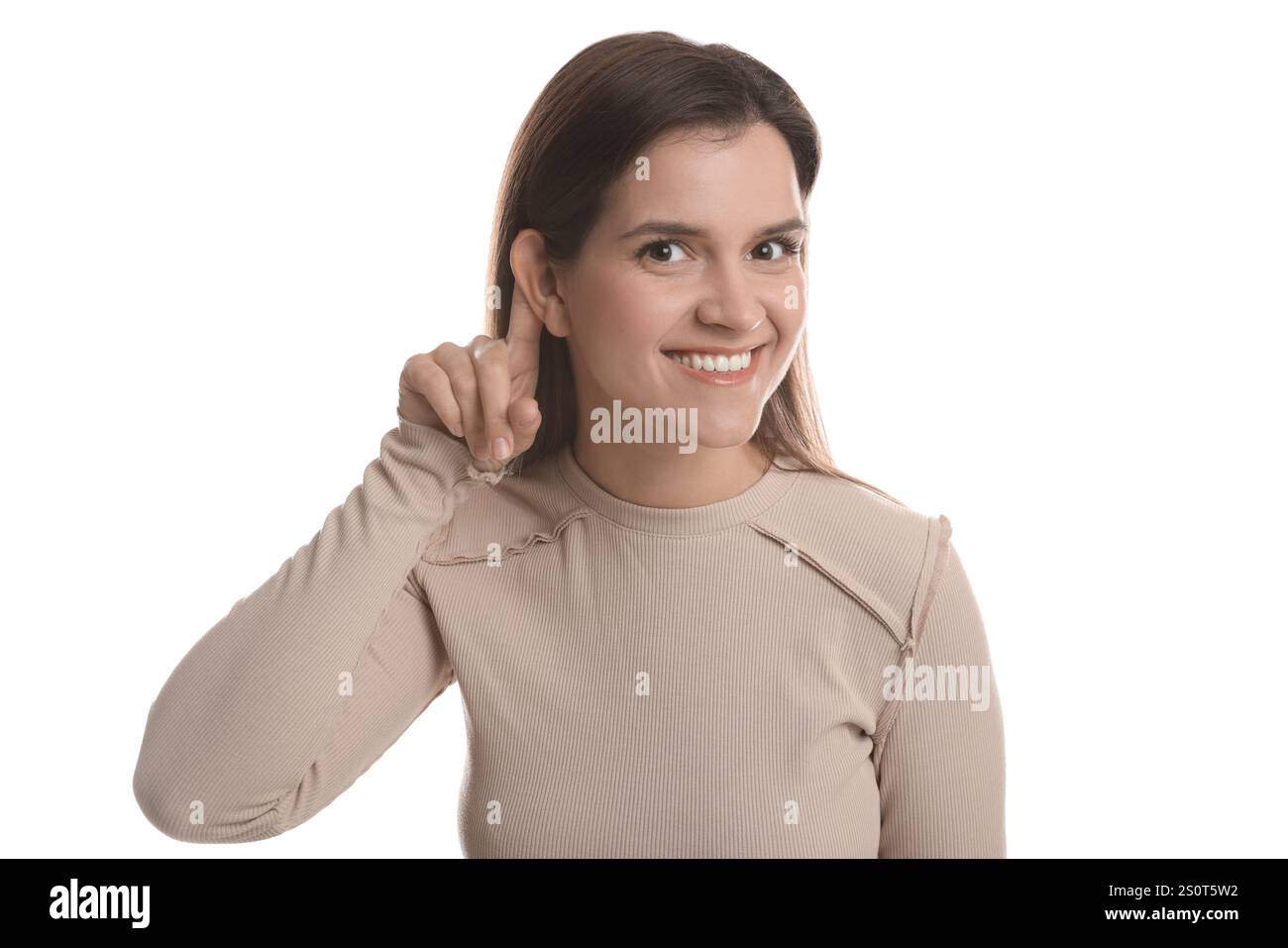 Woman showing hand to ear gesture on white background Stock Photo - Alamy