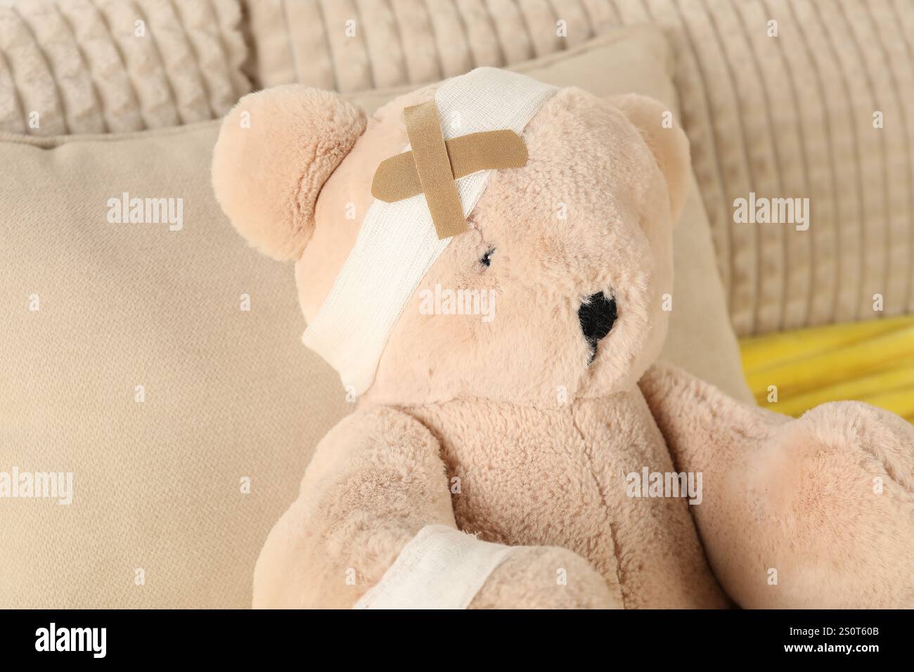 Cute teddy bear with bandages and adhesive medical plasters on bed ...