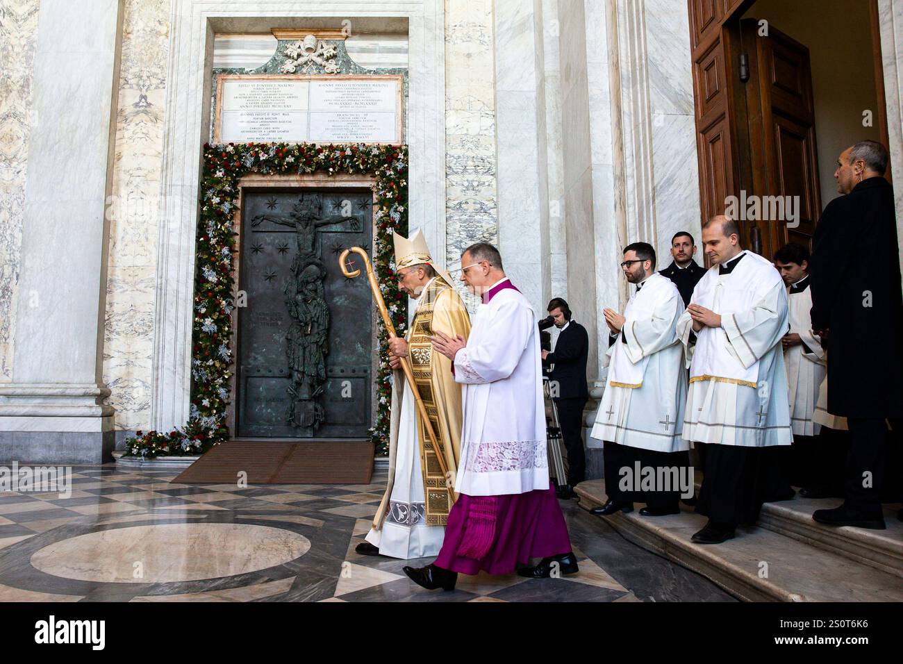 Cardinal Baldassare Reina, left, arrives to open the Holy Door of Rome ...