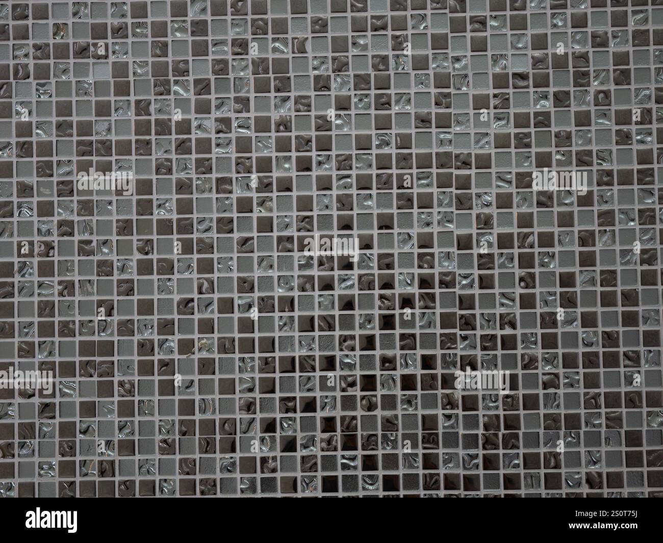 Close-up of a ceramic wall covered with small square mosaic tiles ...