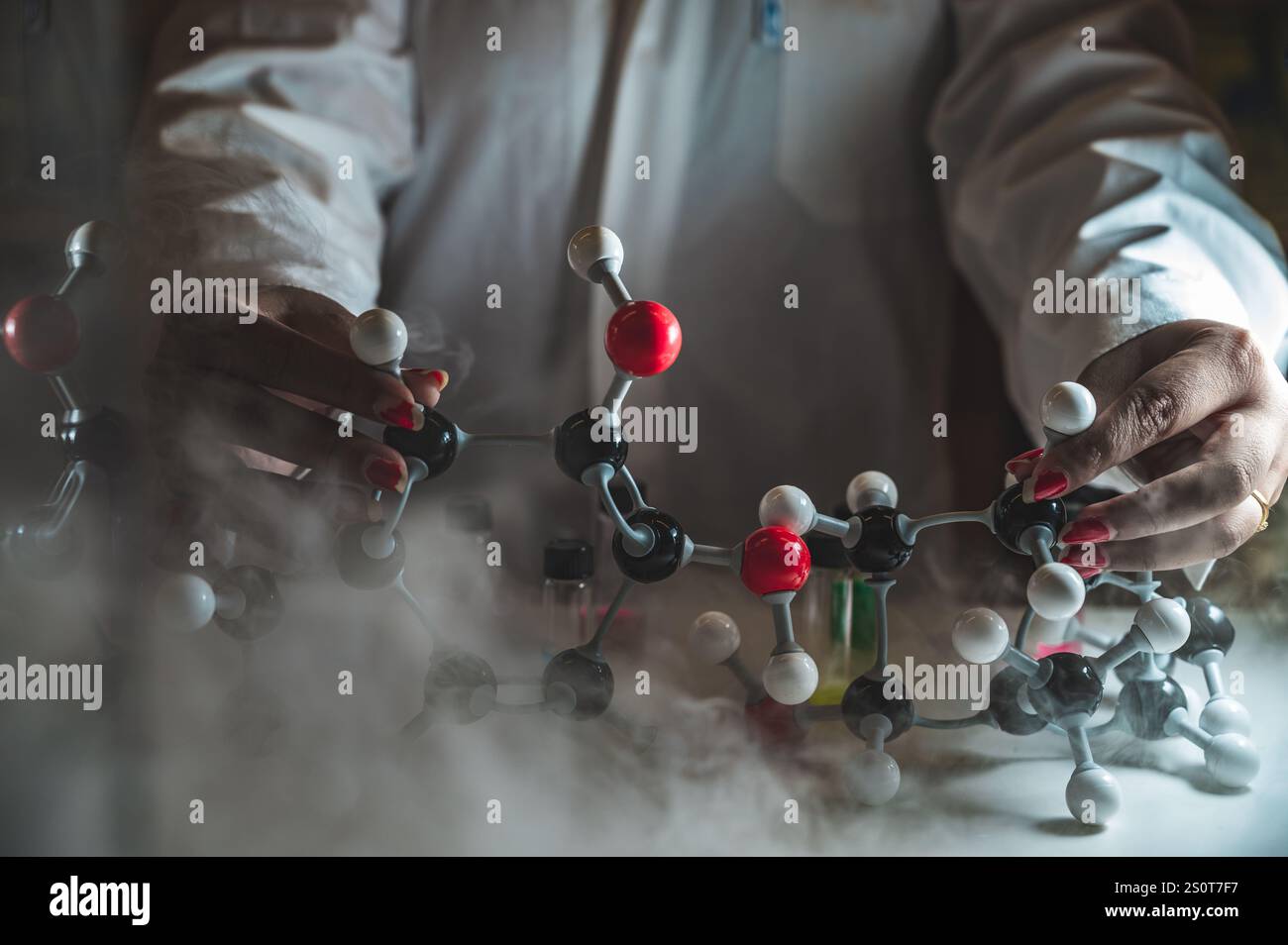 Smoky experiments with molecular model. Scientist working on chemical ...