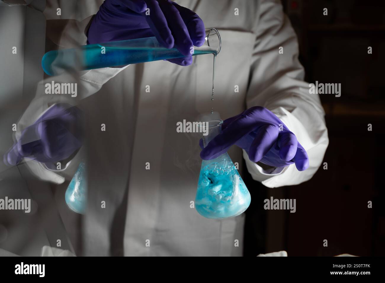 Smoky experiments with blue droplets. Scientist working on chemical reaction, generating thick ...