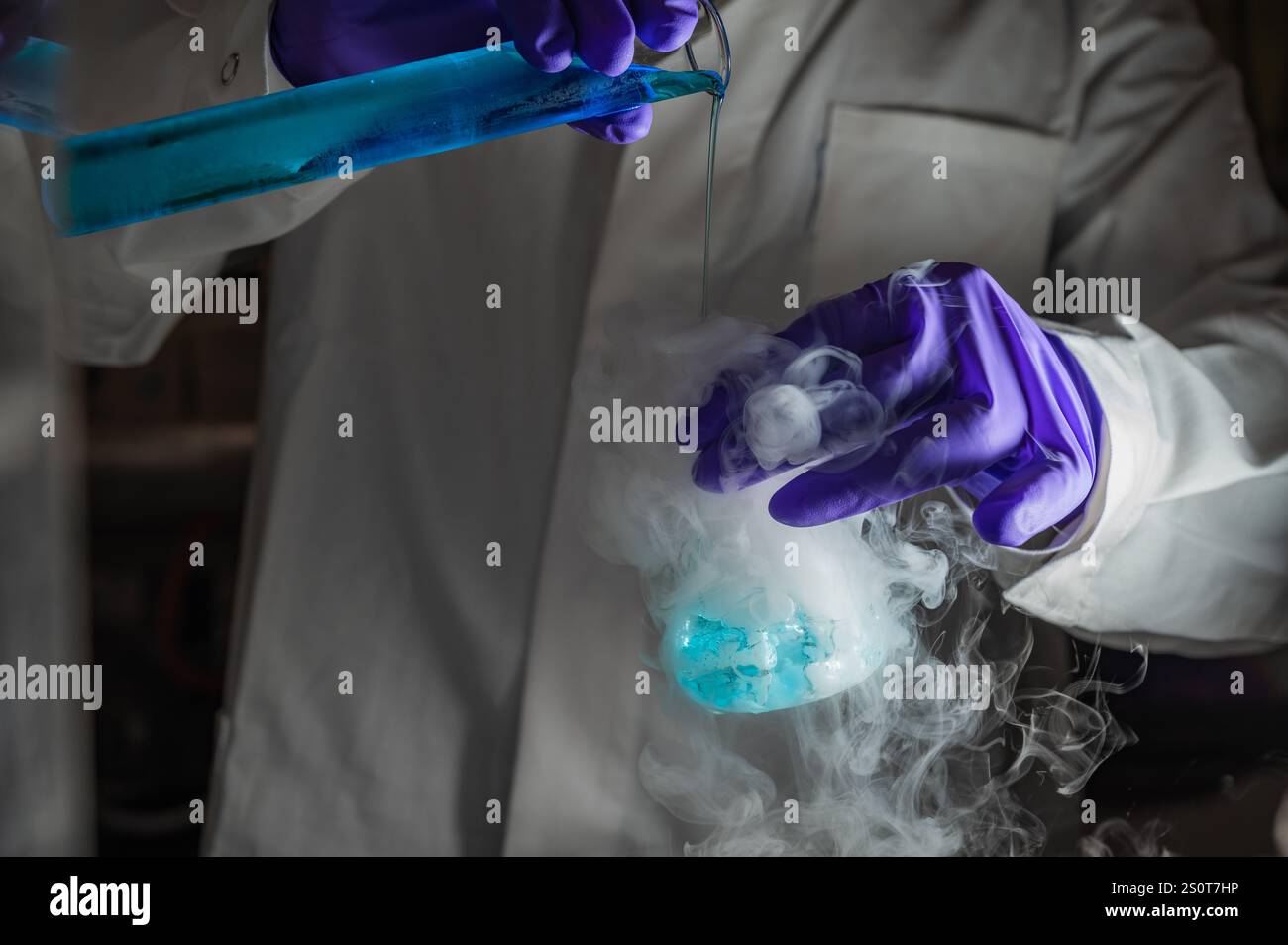 Smoky experiments with blue droplets. Scientist working on chemical ...