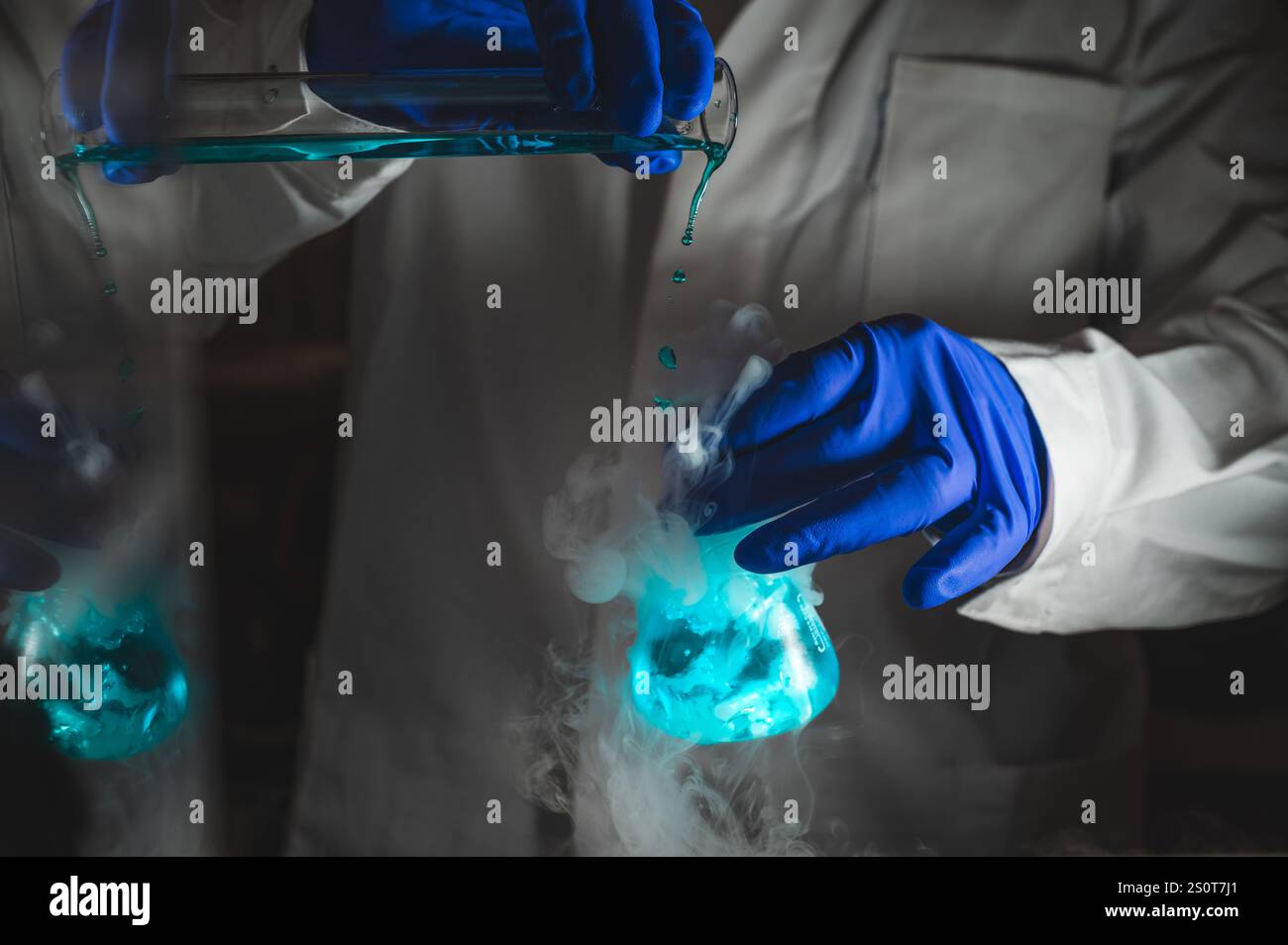 Smoky experiments with blue colour solution. Scientist working on ...