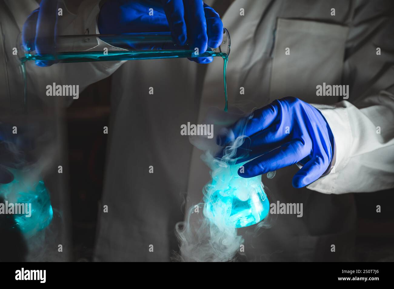 Smoky experiments with blue colour solution. Scientist working on ...