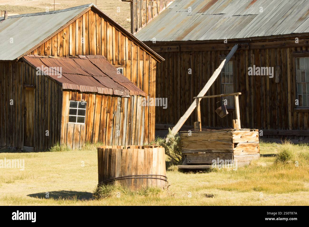 A small, old-fashioned building with a large wooden structure in front ...