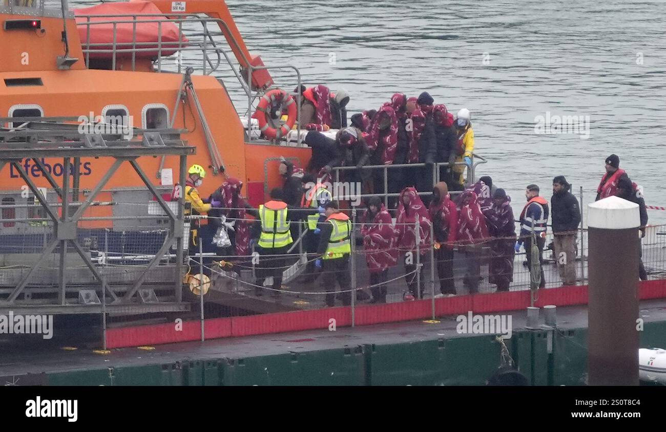A group of people thought to be migrants are brought in to Dover, Kent ...