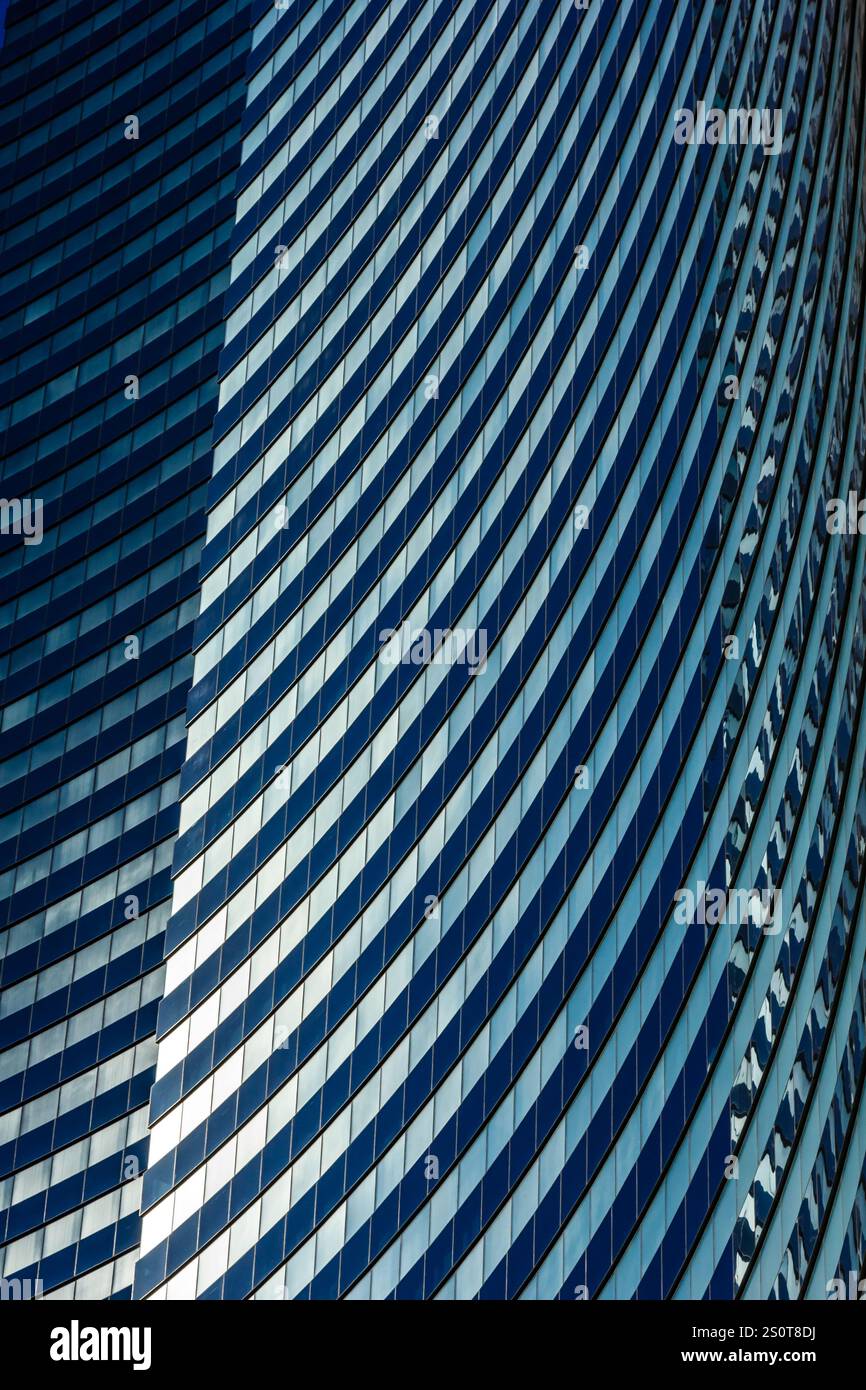 The image is of a tall building with a blue and white striped facade ...