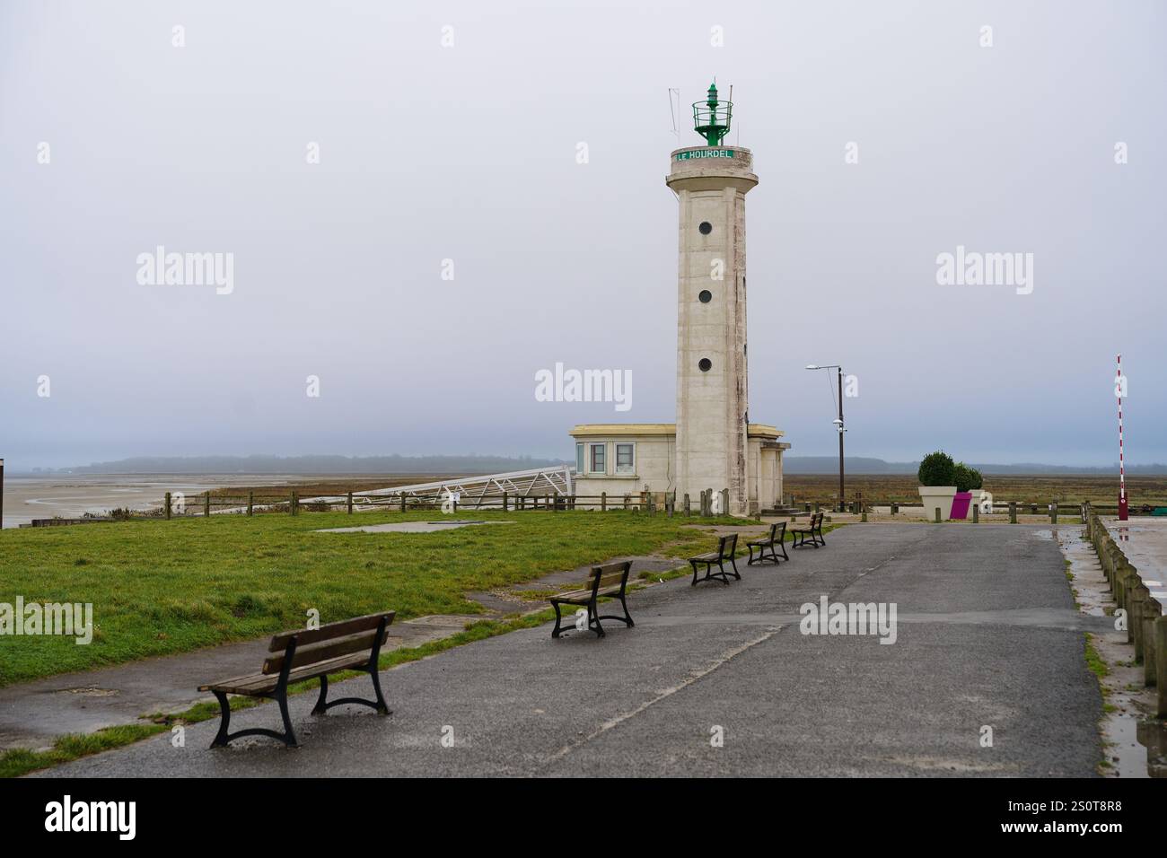 Historic lighthouse stands tall beside the sea, surrounded by empty ...