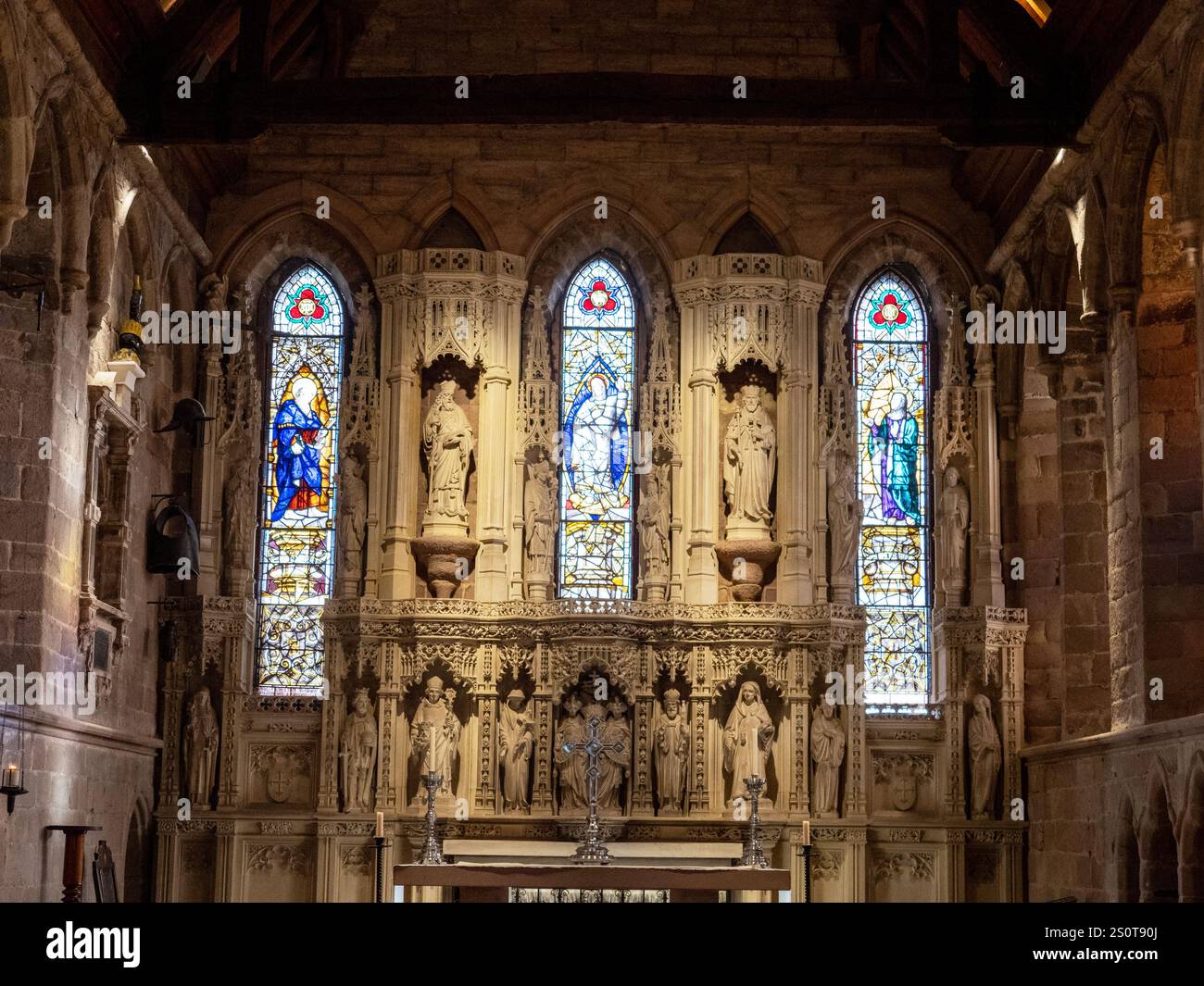 Stained glass and the altar in St Aiden's Church in Bamburgh ...