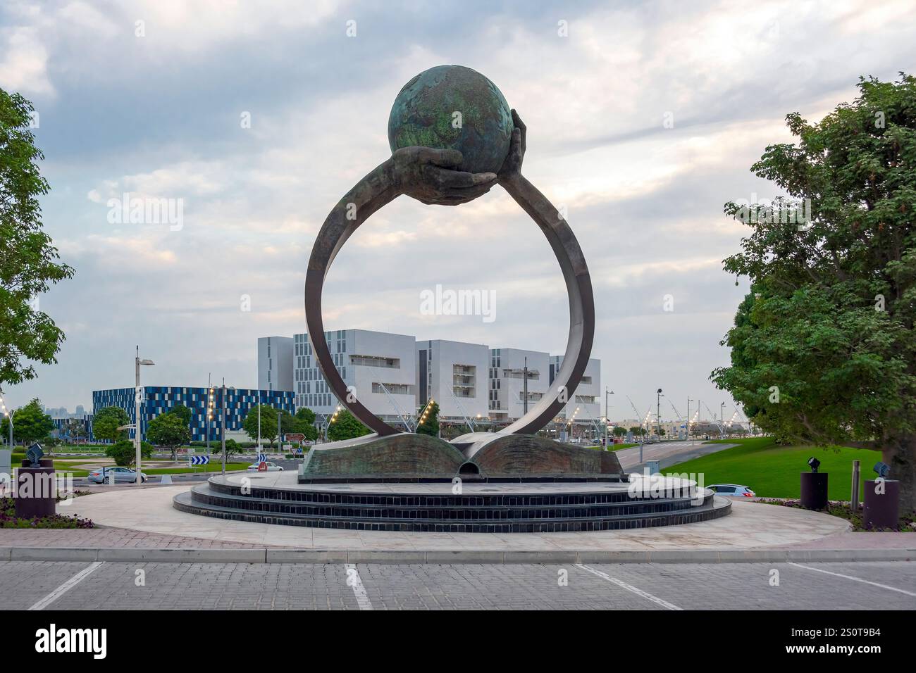 Hands rising from a book support the globe in this sculpture at Qatar ...