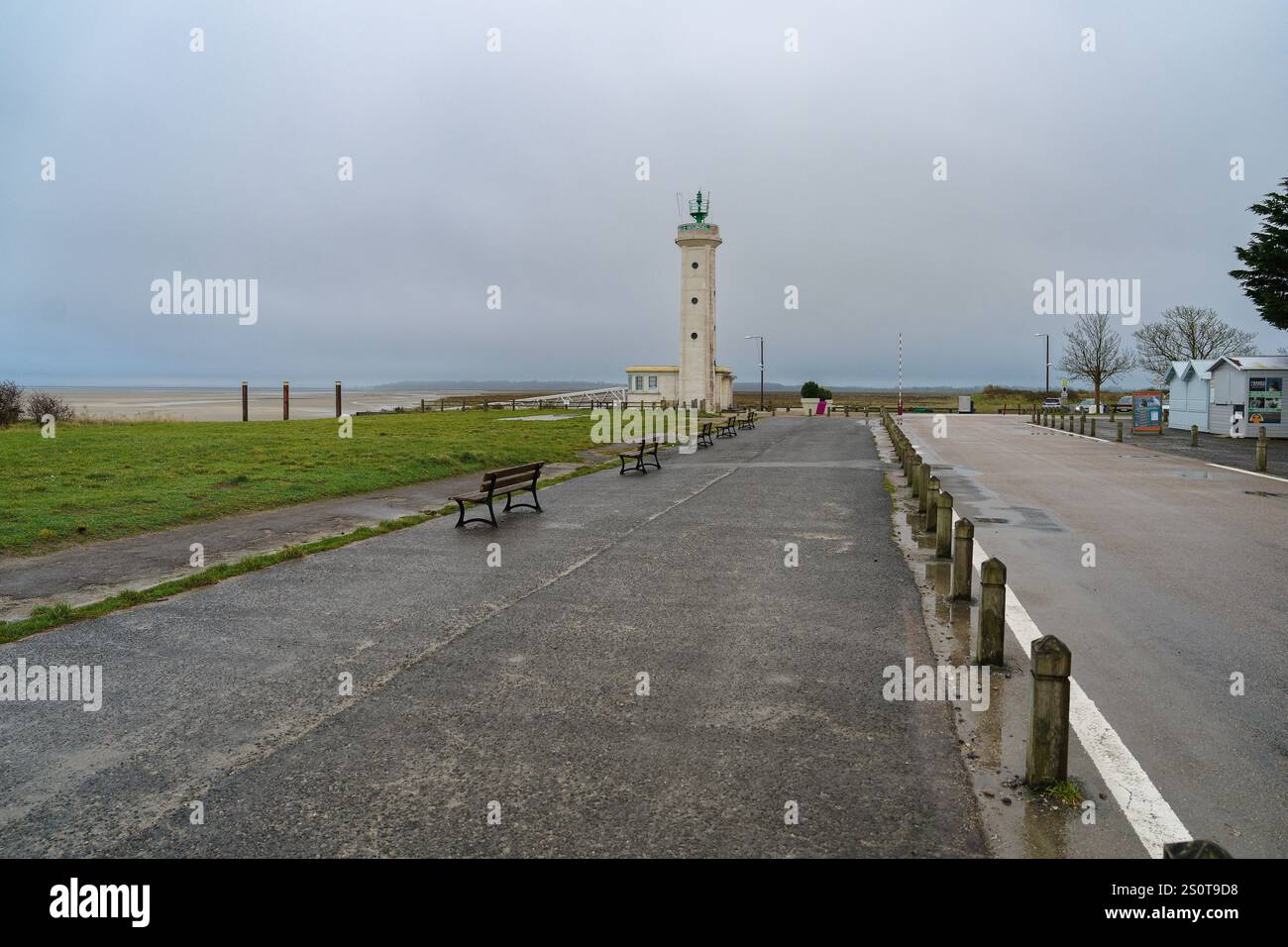 Coastal promenade with lighthouse and benches near the shore during ...