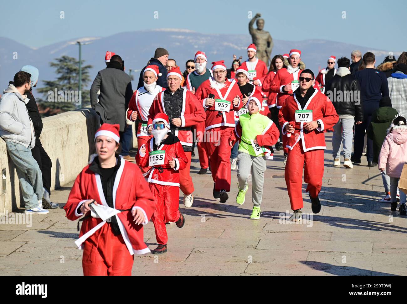 Participants dressed as Santa Clauses run during the traditional Santa ...