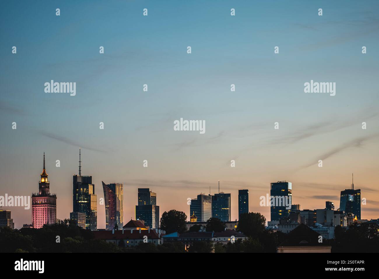 sunset over skyline of big modern city with skyscrapers and downtown ...