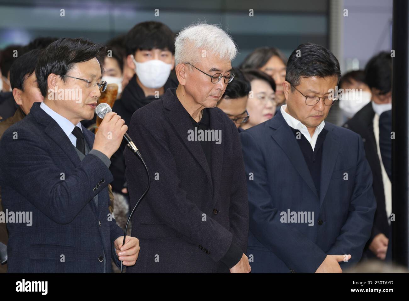 Jeju Air CEO Kim E-bae , left, speaks in apology to relatives of passengers at the Muan ...