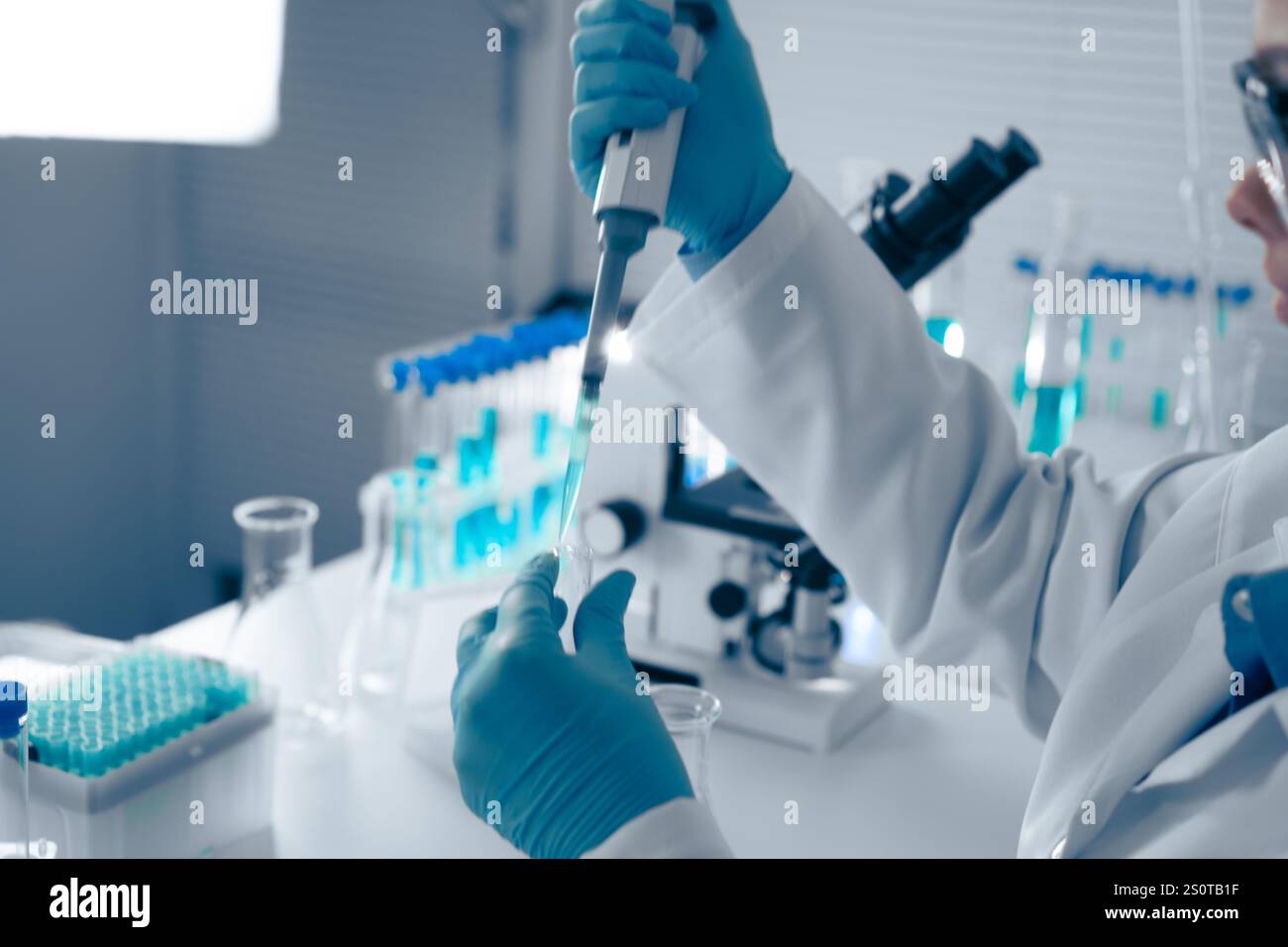 A skilled Laboratory Scientist expertly uses a pipette, an essential ...