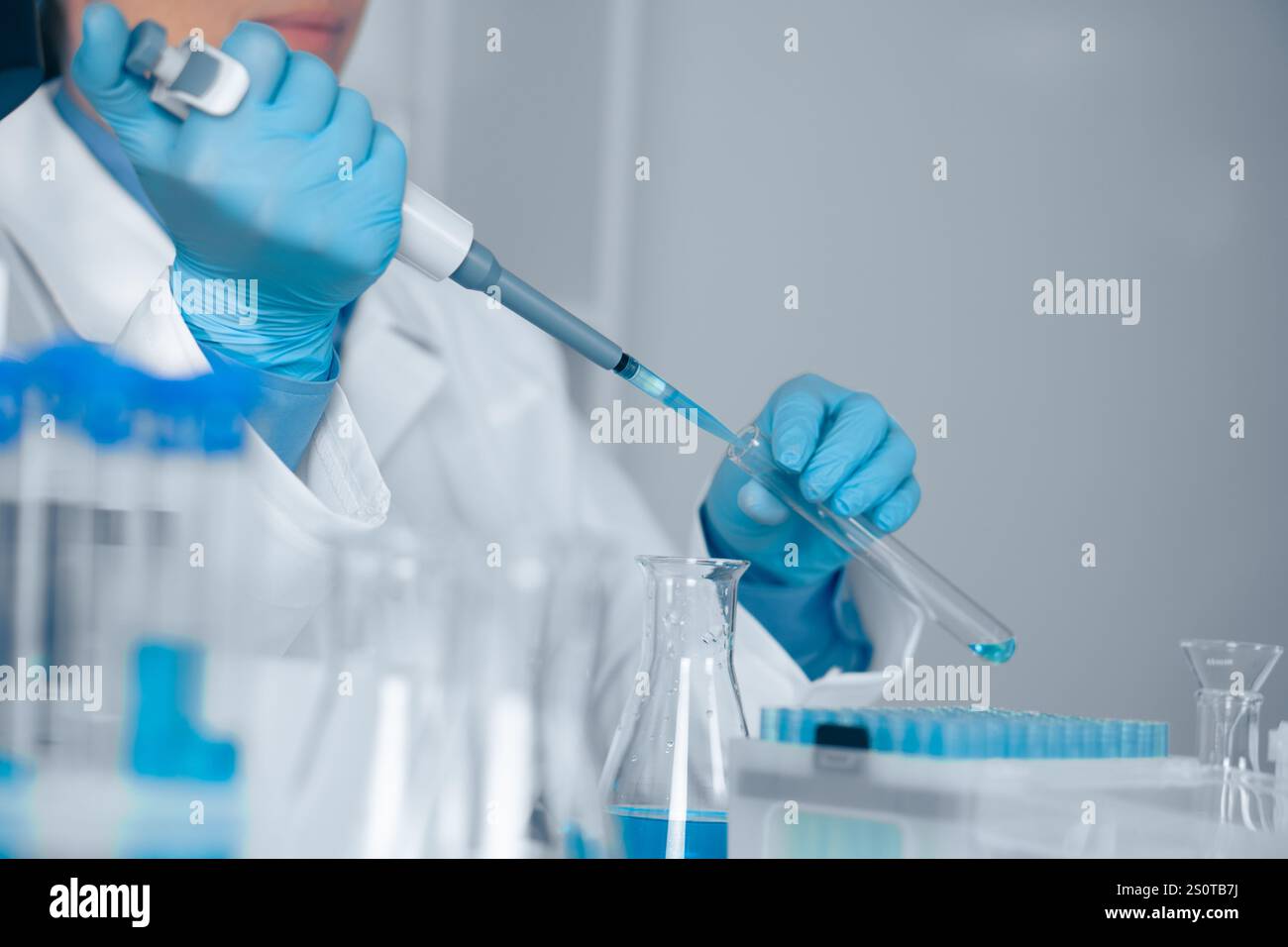 A skilled Laboratory Technician uses precise pipetting techniques ...