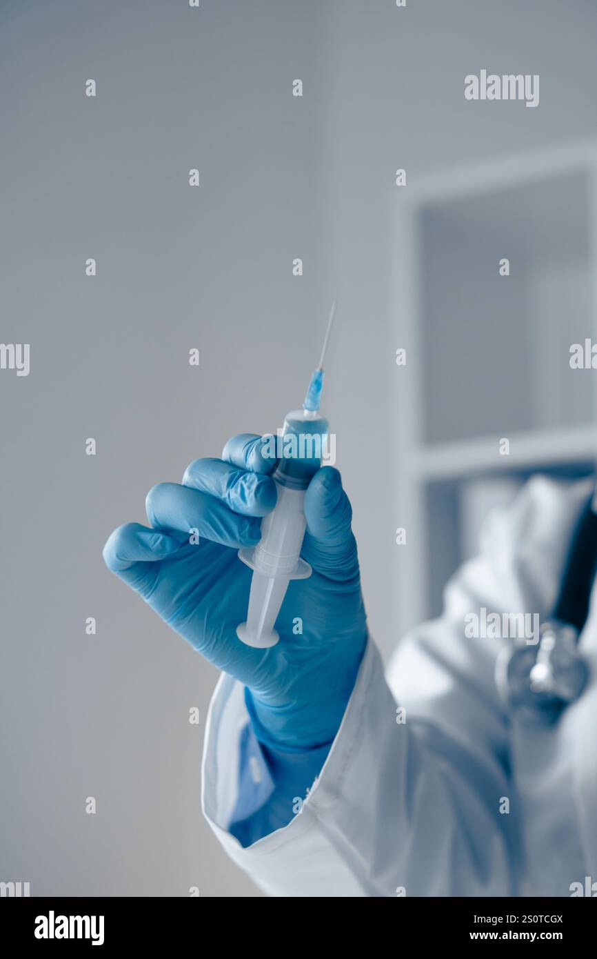 A Healthcare Professional Expertly Holding a Syringe in a Safe, Clean ...