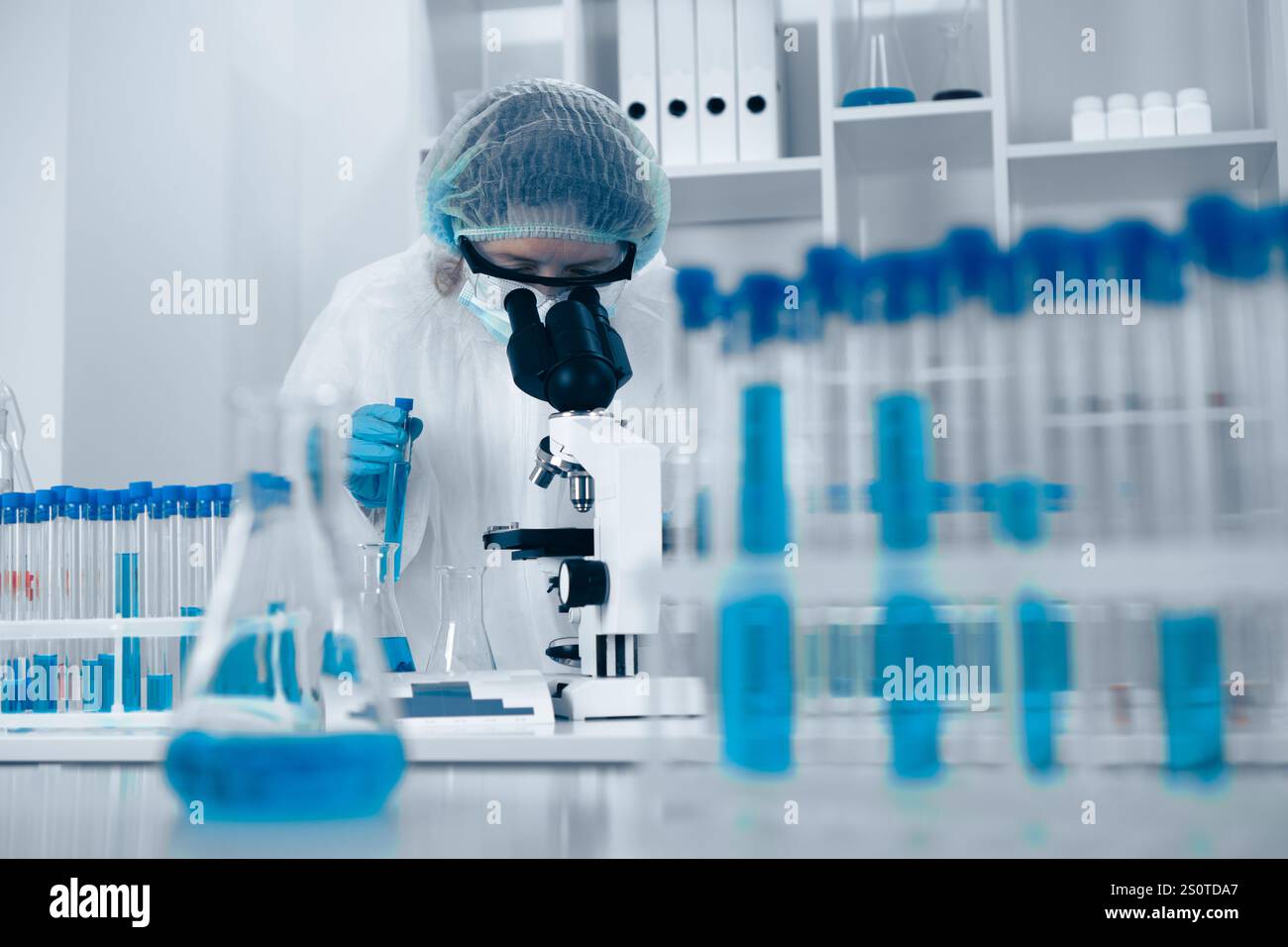 In a cuttingedge lab, a dedicated scientist is carefully examining ...