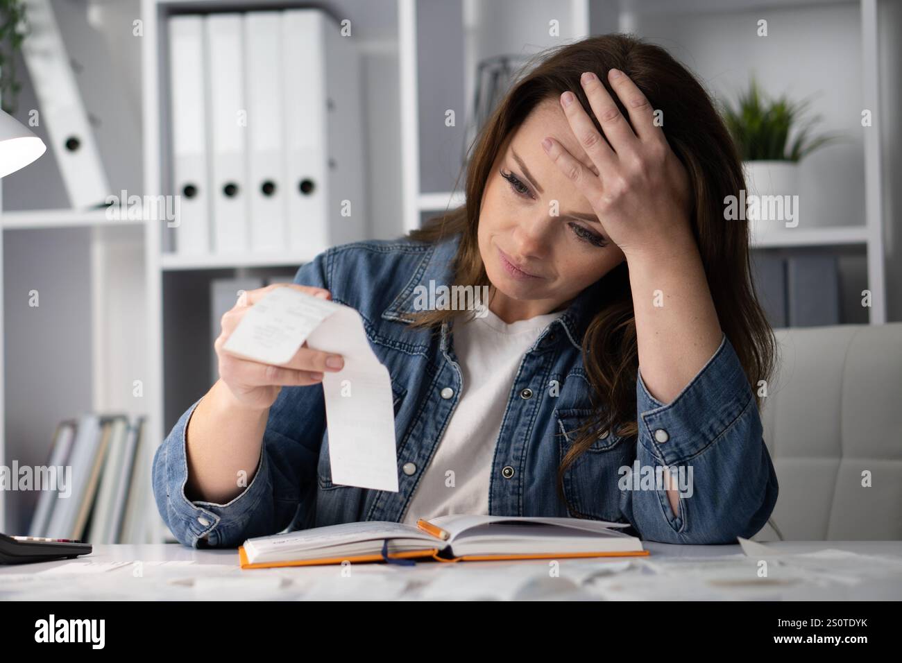 A Frustrated Woman is Thoroughly Reviewing Receipts and Financial ...