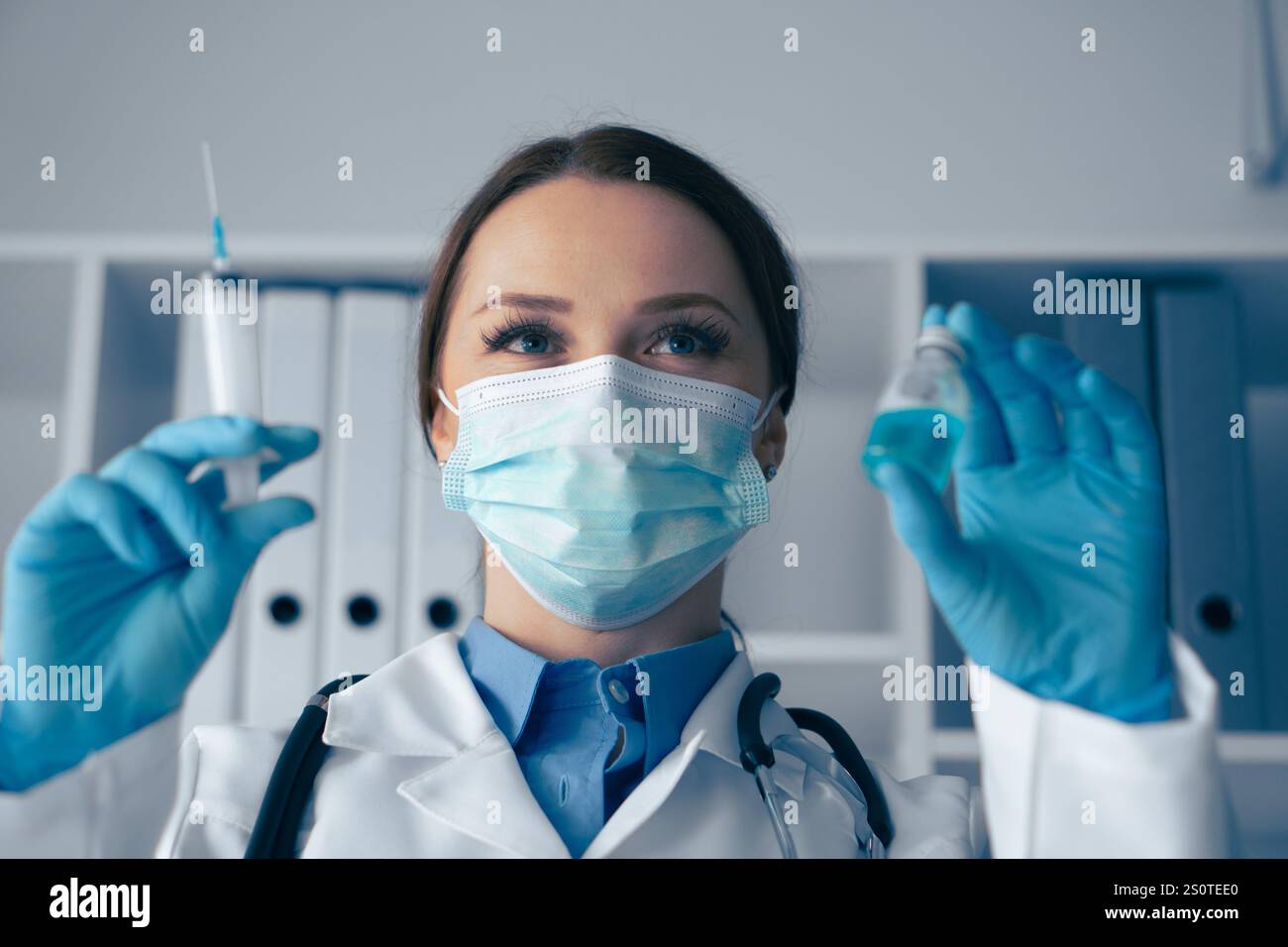 A dedicated medical professional carefully preparing an injection using ...