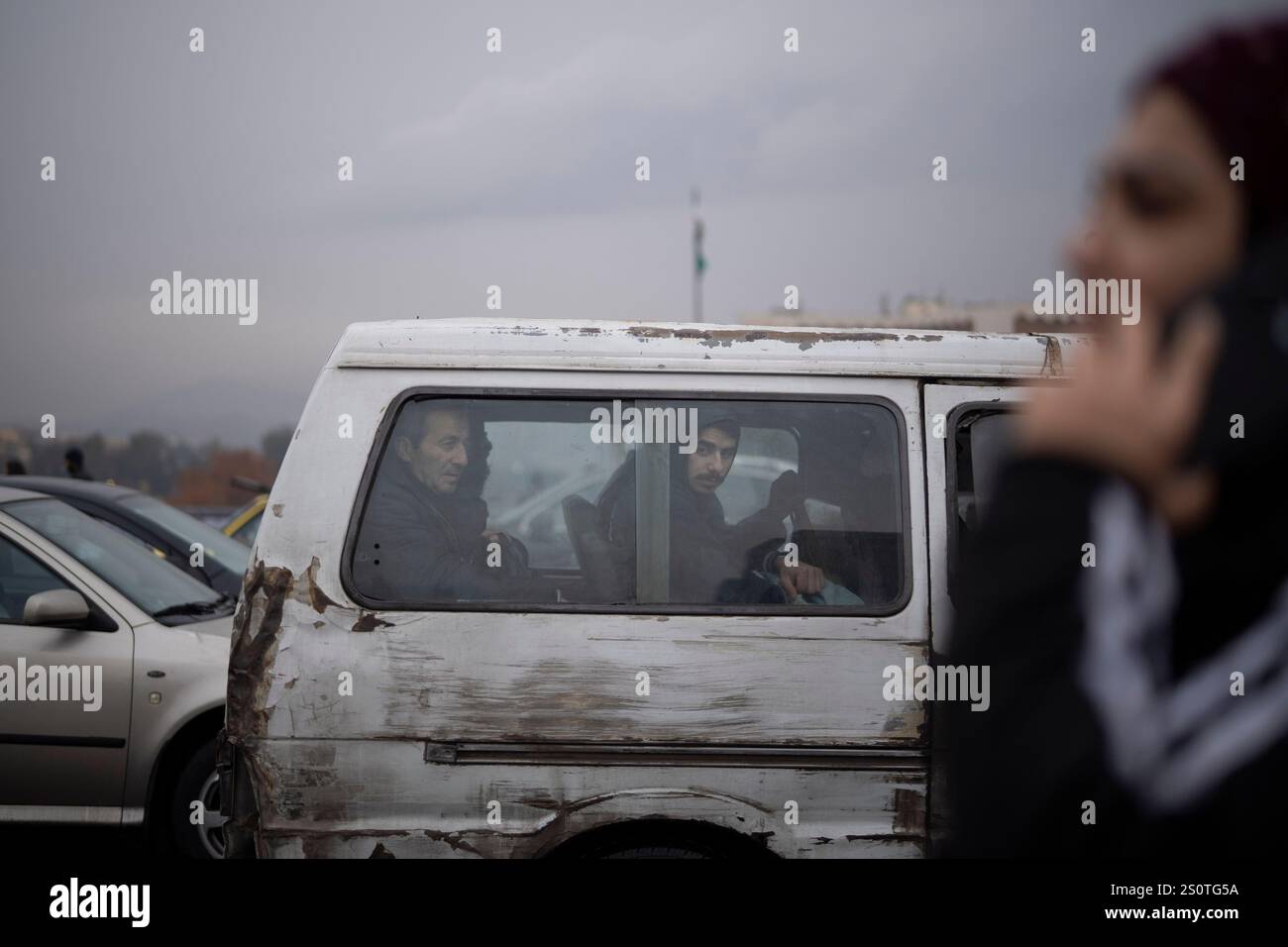 Commuters ride on a transportation van in Damascus, Syria, Sunday, Dec ...