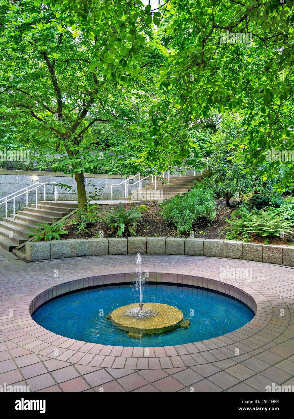 Small inner yard of residential area with fountain in downtown of ...