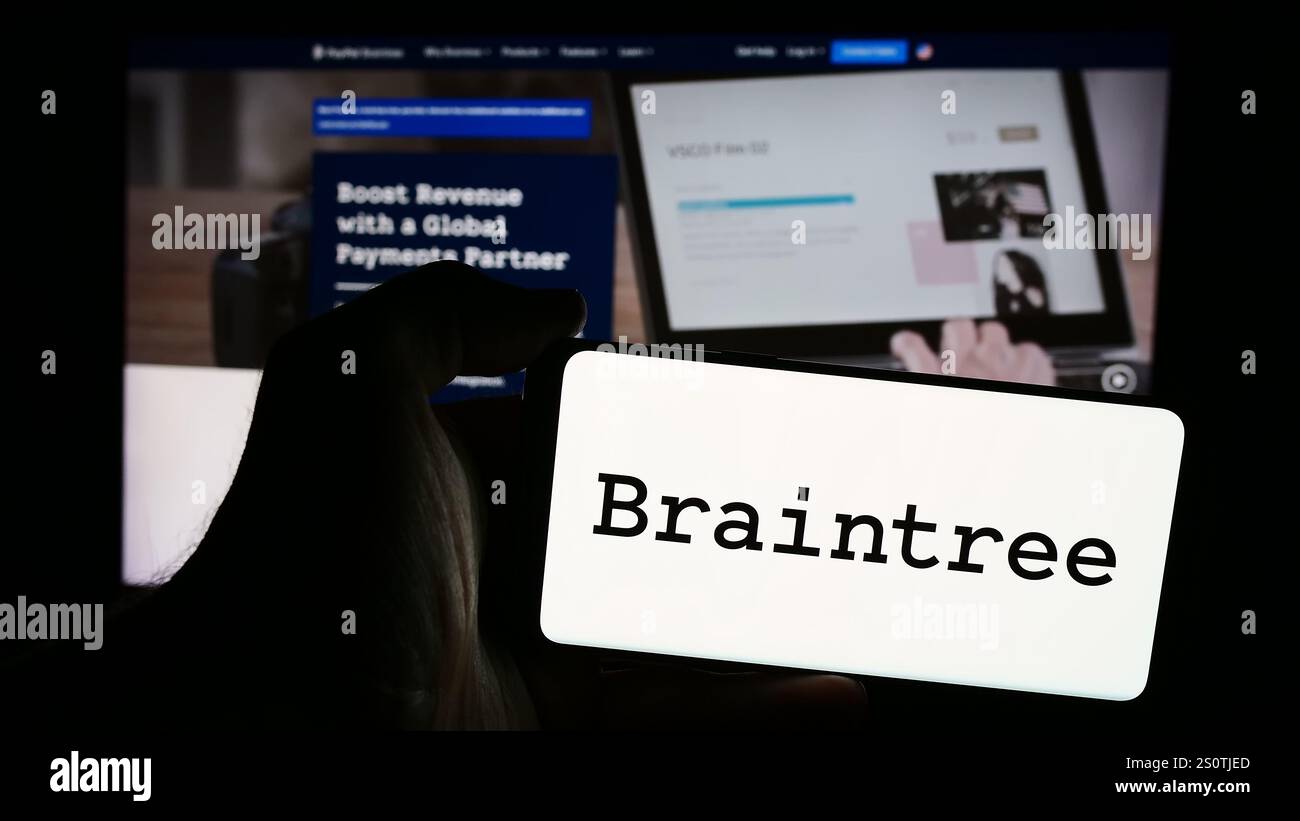 In this photo illustration, a person is holding a mobile phone with the logo of British payment ...