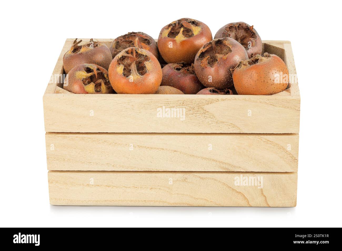 Brown fresh medlars in wooden box isolated on white background ...