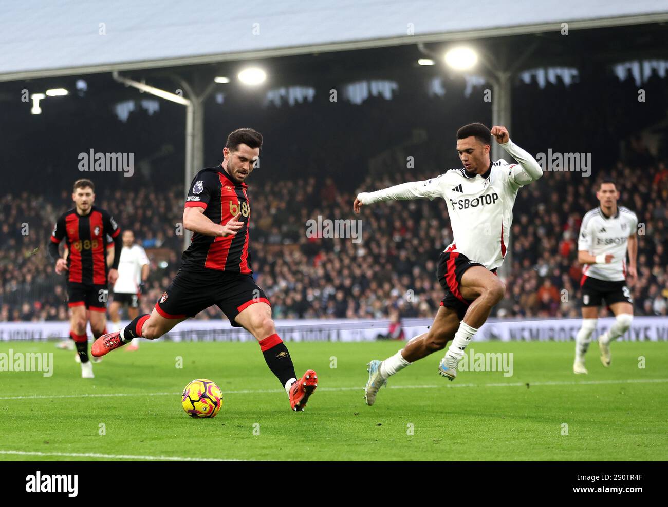 Bournemouth's Lewis Cook (left) and Fulham's Antonee Robinson battle ...
