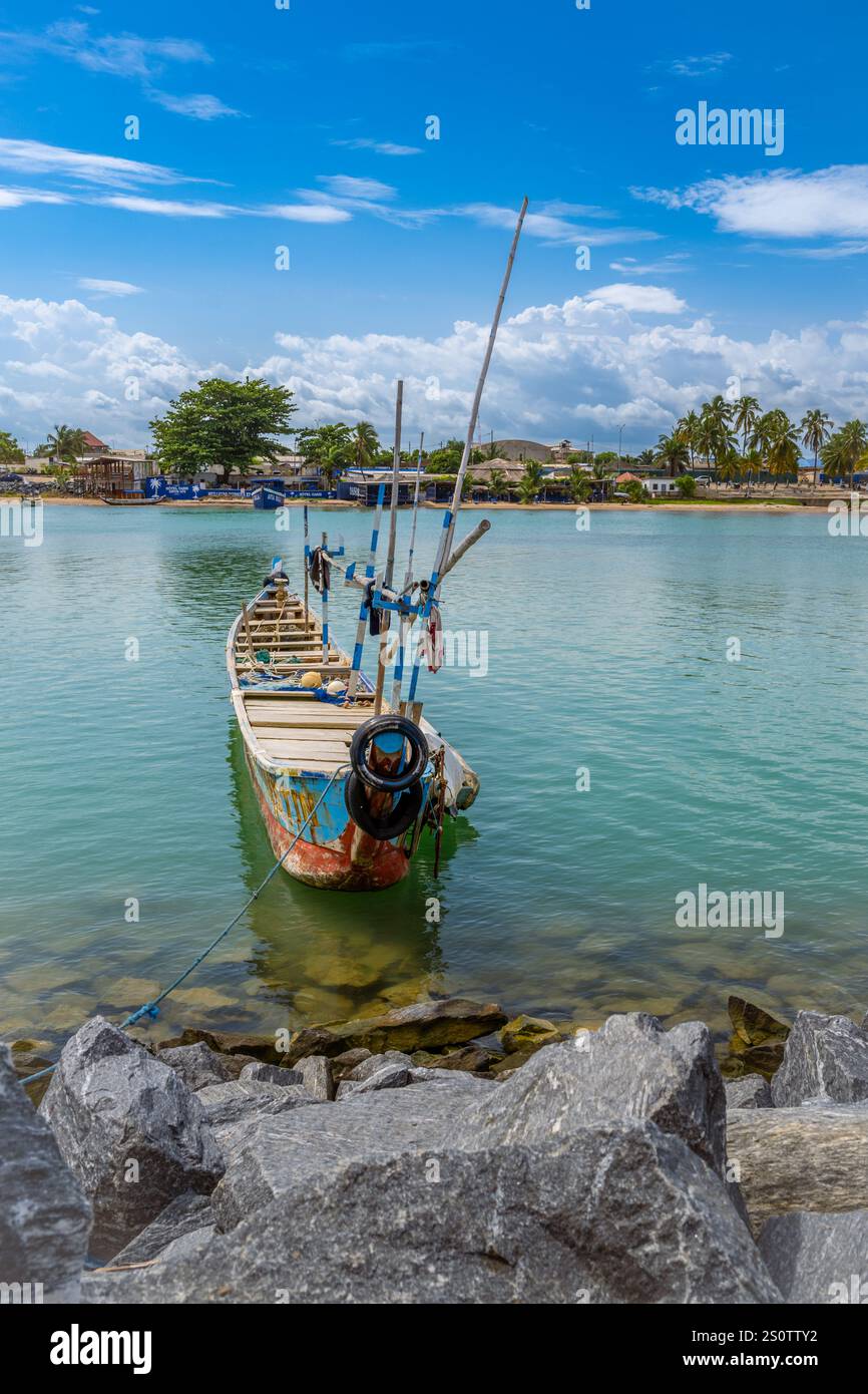 Traditional African fishing colorful fishing boats in port reflecting ...
